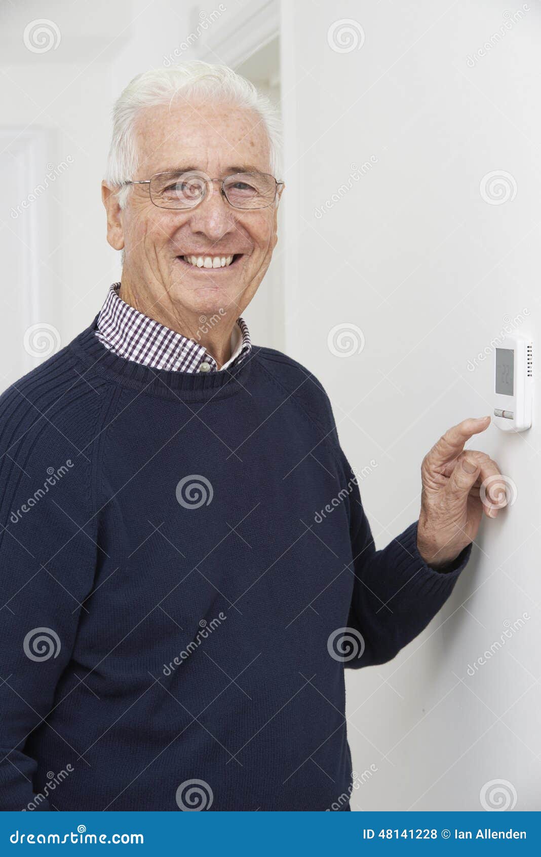 Smiling Senior Man Adjusting Central Heating Thermostat Stock Photo ...