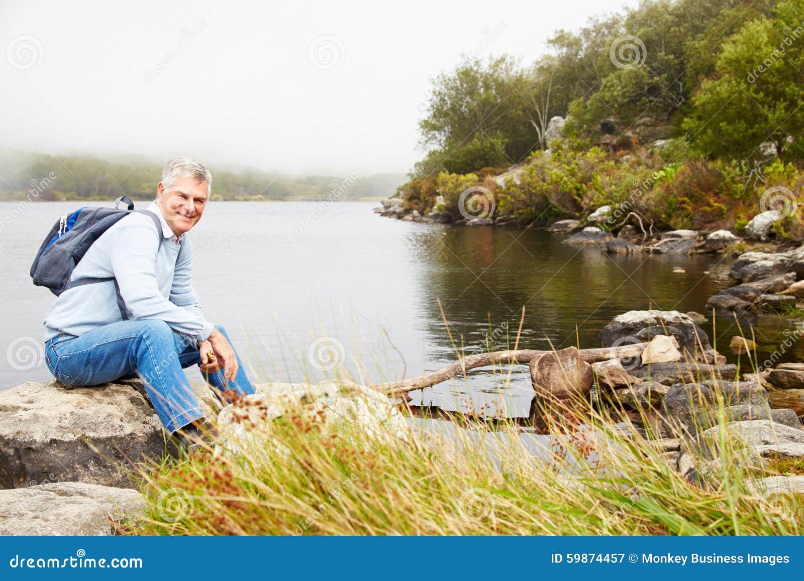 Smiling Senior Man Sitting by a Lake Stock Image - Image of leisure ...