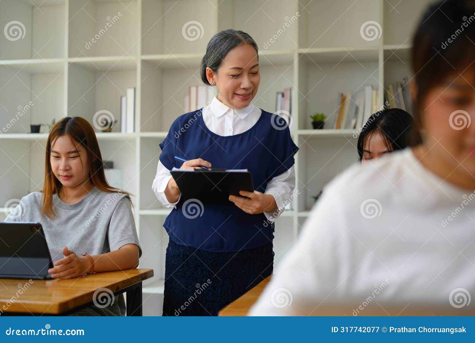 Smiling Senior Professor Talking To Students while Walking Around ...