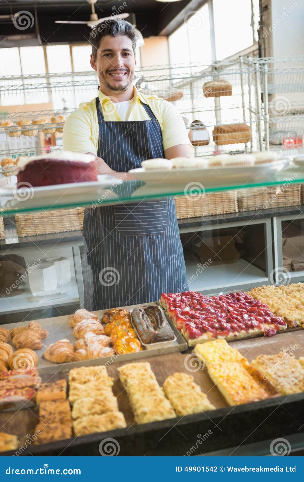 Smiling Server Standing with Arms Crossed Behind the Counter Stock ...