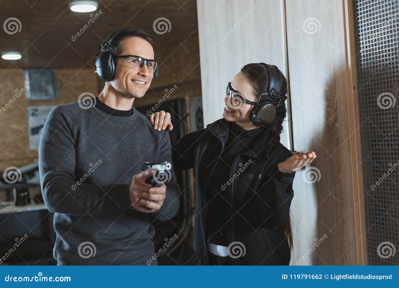 Smiling Shooting Instructor Supporting Client Stock Photo - Image of ...