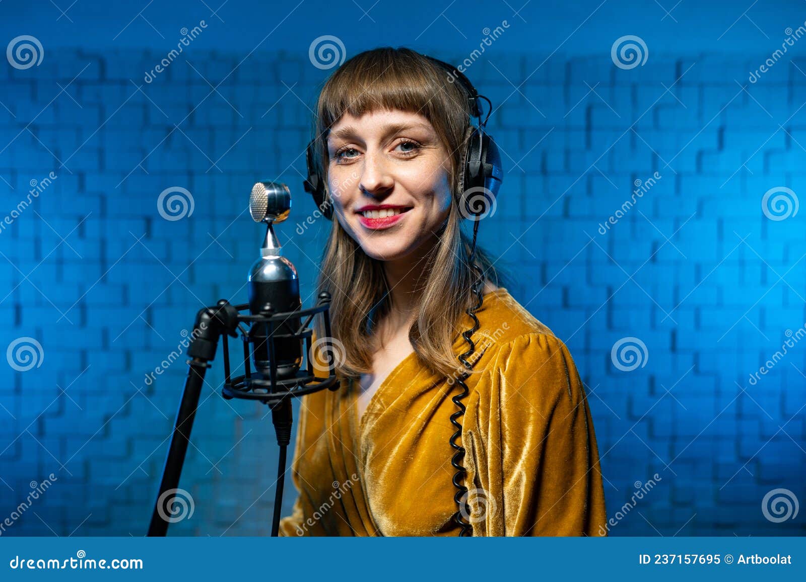 Smiling Singer in Headphones in Front of the Microphone Stock Image ...