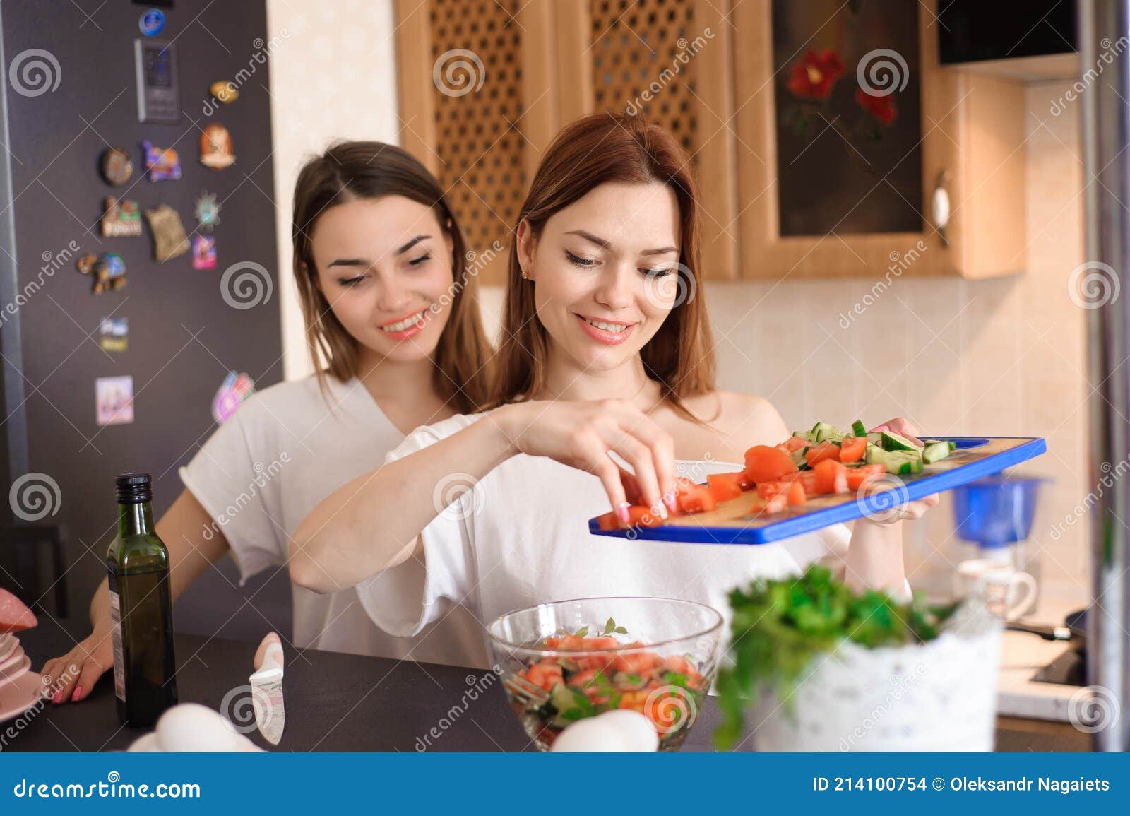 Smiling Sisters Preparing Dinner Together in the Kitchen. Stock Photo ...