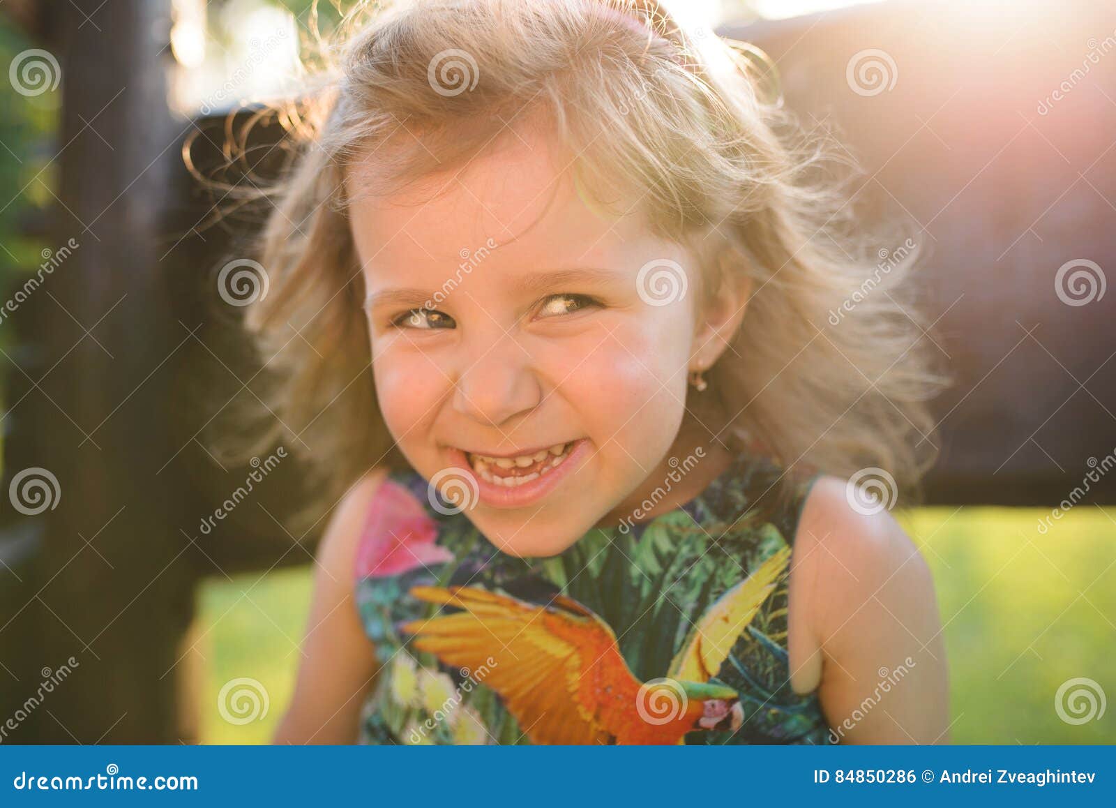 Smiling Sly Girl stock photo. Image of innocence, grass - 84850286