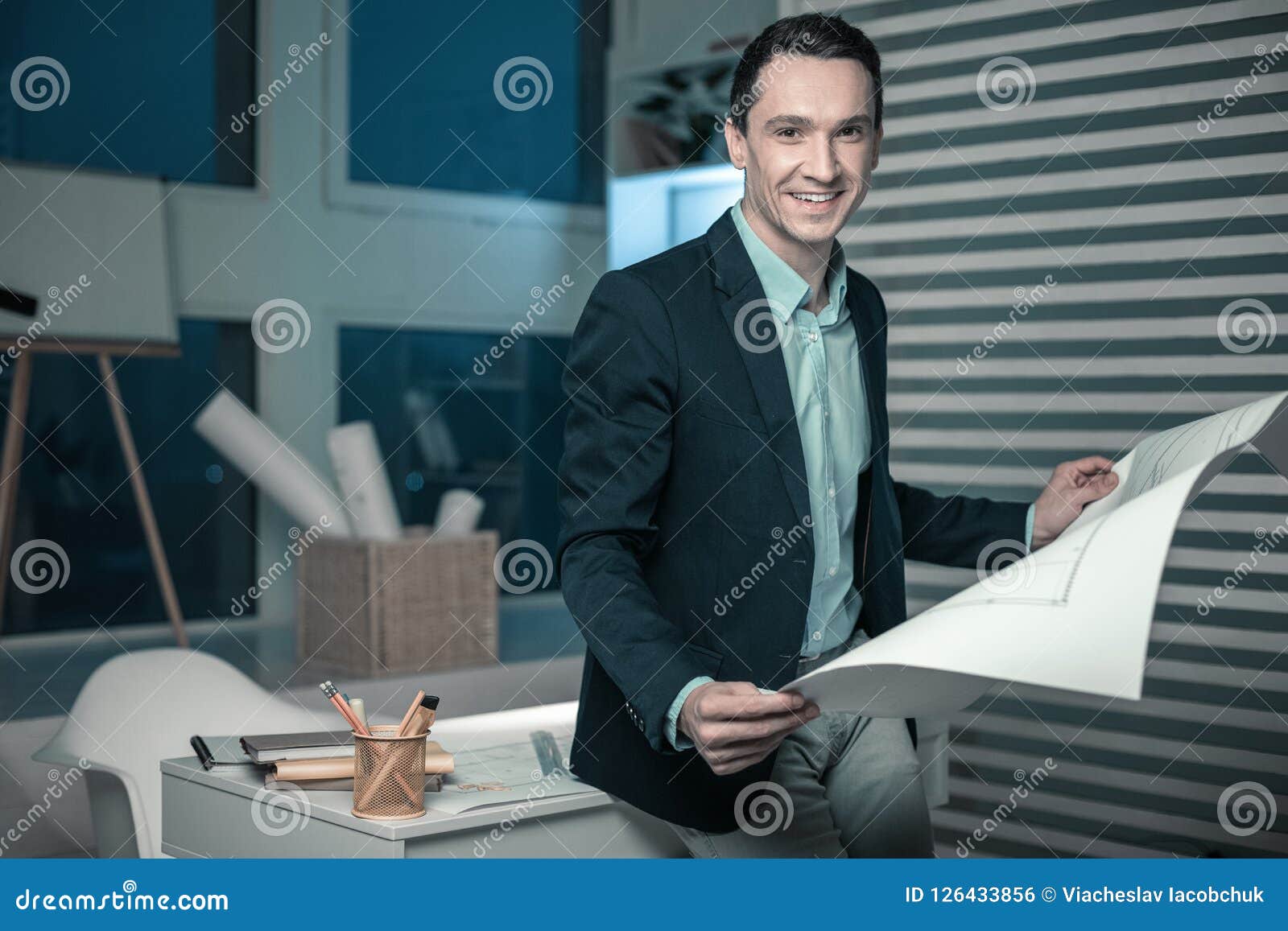 Smiling Smart Man Exploring a Drawings for Project Stock Photo - Image ...