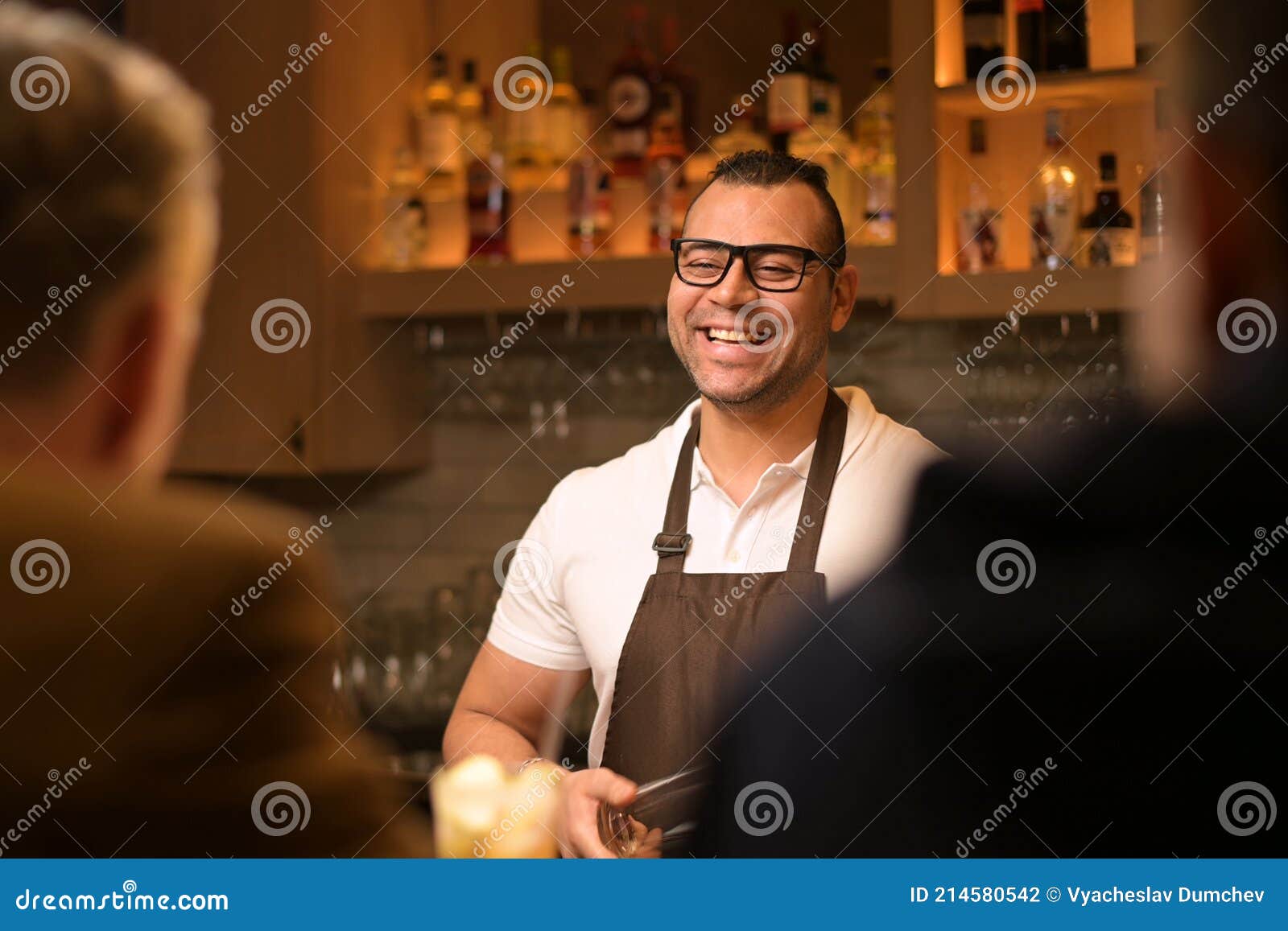 Smiling and Sociable Bartender Conducts a Conversation with Customers ...