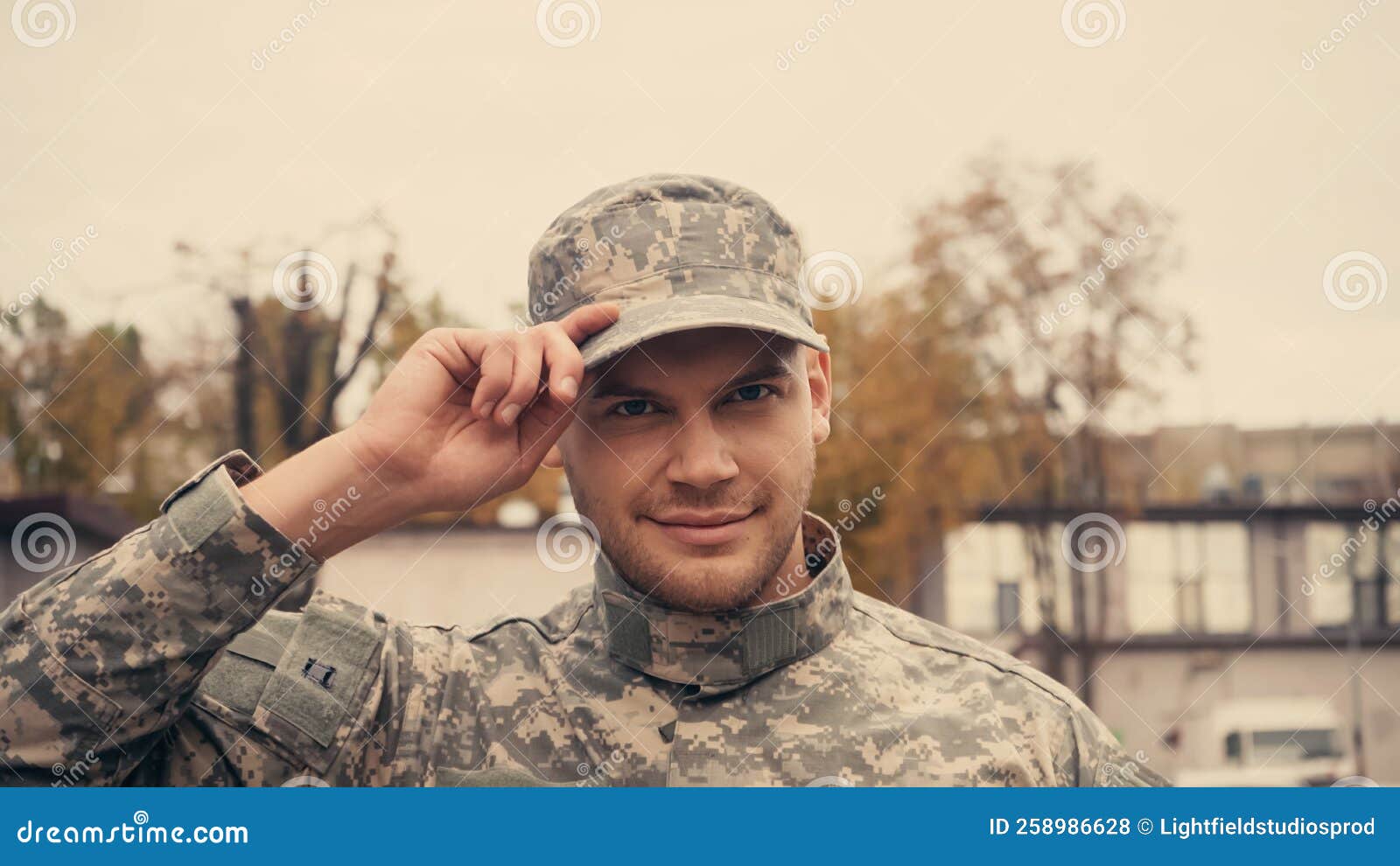 Smiling Soldier in Uniform Adjusting Cap Stock Photo - Image of ...