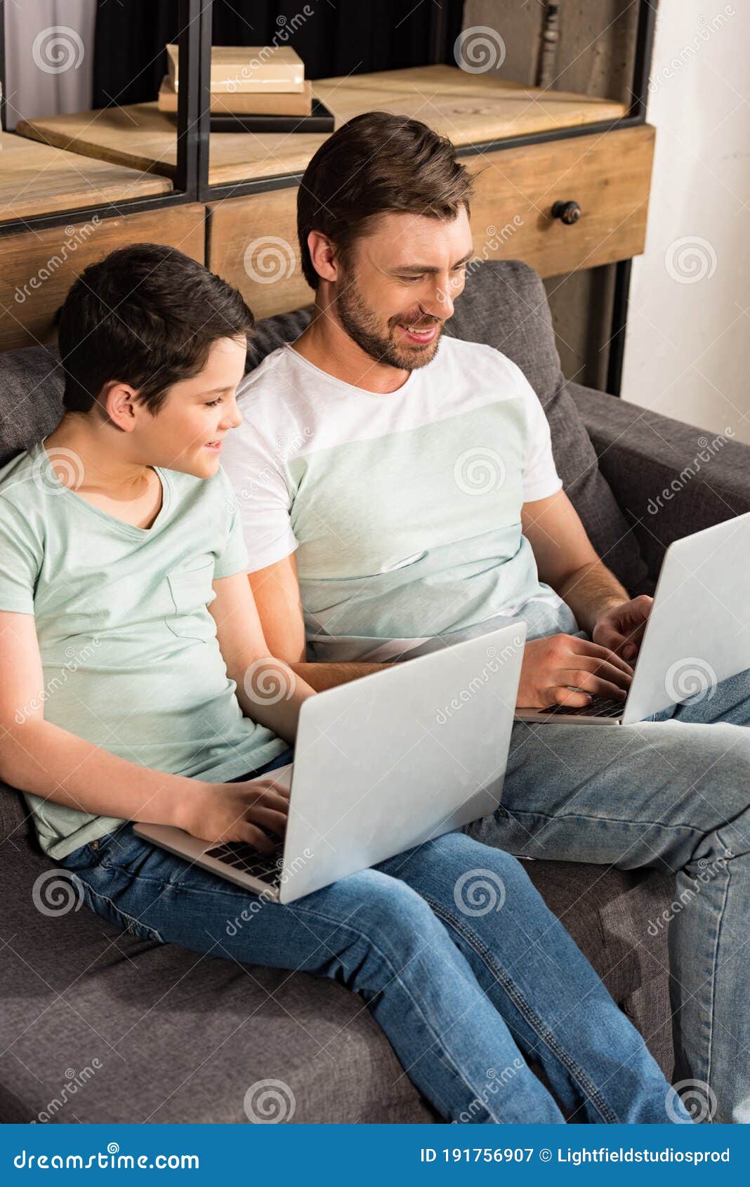 Son and Dad Using Laptops in Living Room Stock Image - Image of indoors ...