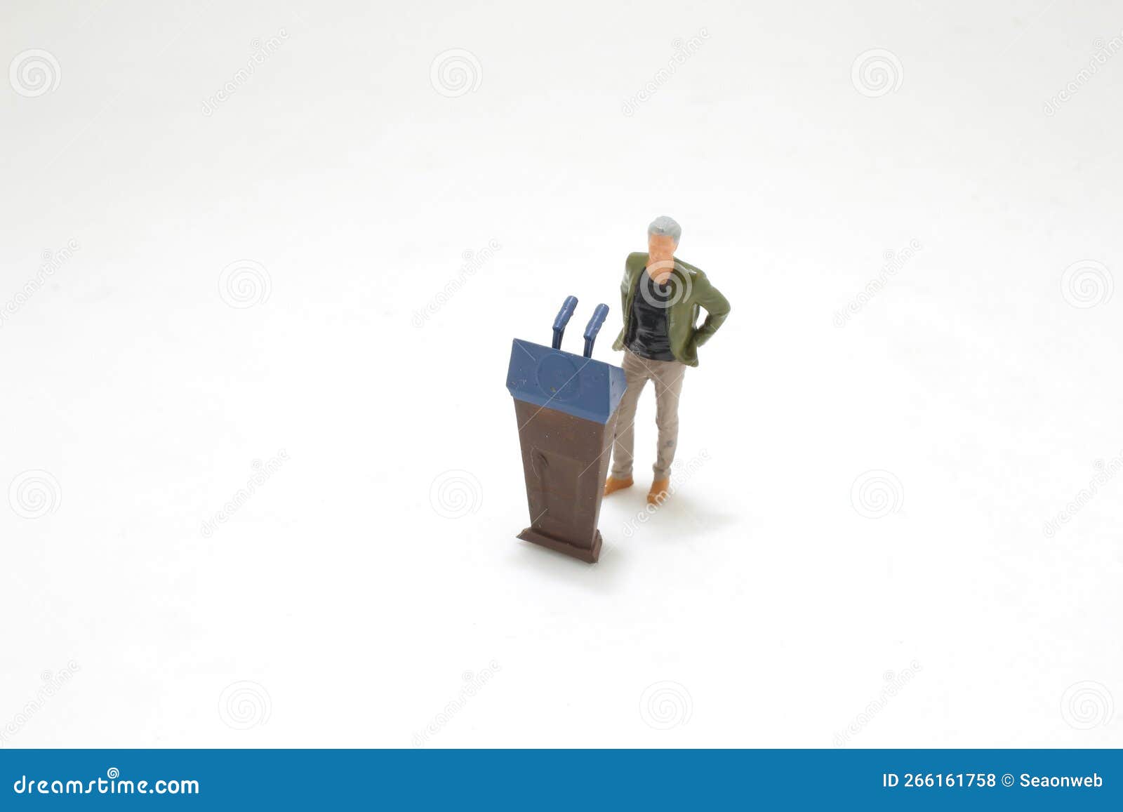 A Smiling Speaker Gesturing and Talking into Microphone Stock Photo ...