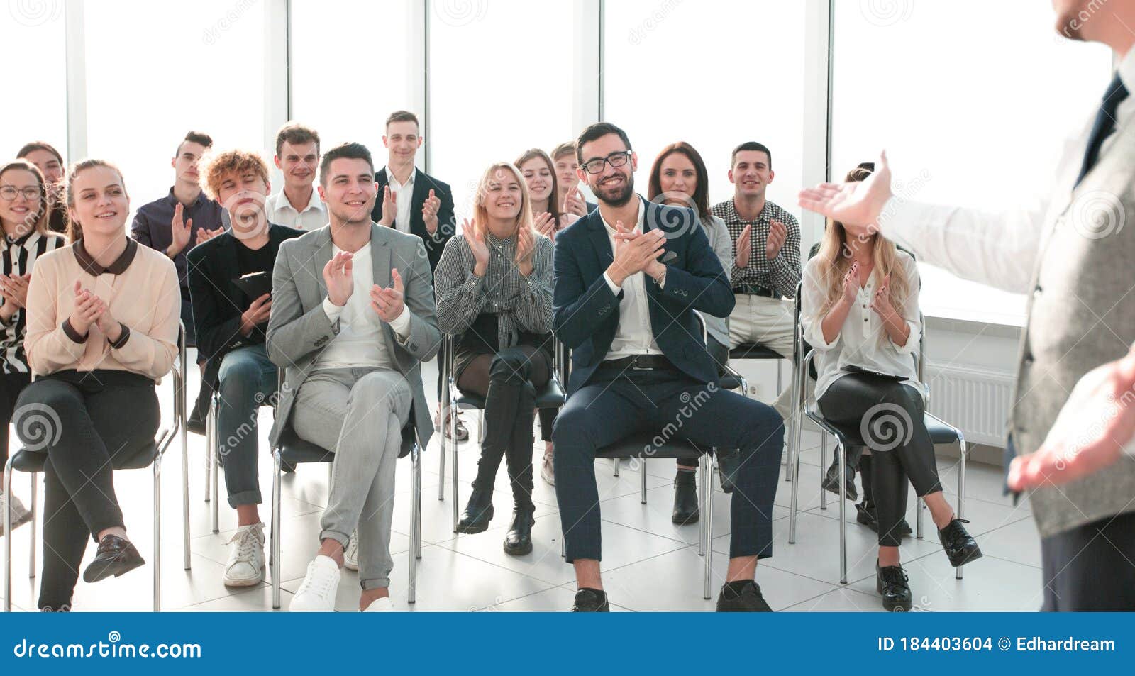Smiling Speaker Standing in Front of an Applauding Audience Stock Photo ...
