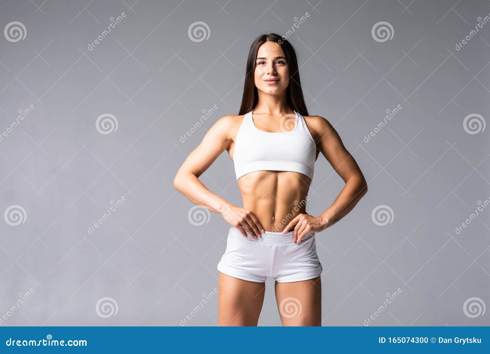 Smiling Sports Woman Standing with Arms Folded and Looking at Camera ... Smiling Sports Woman Standing with Arms Folded and Looking at Camera ...