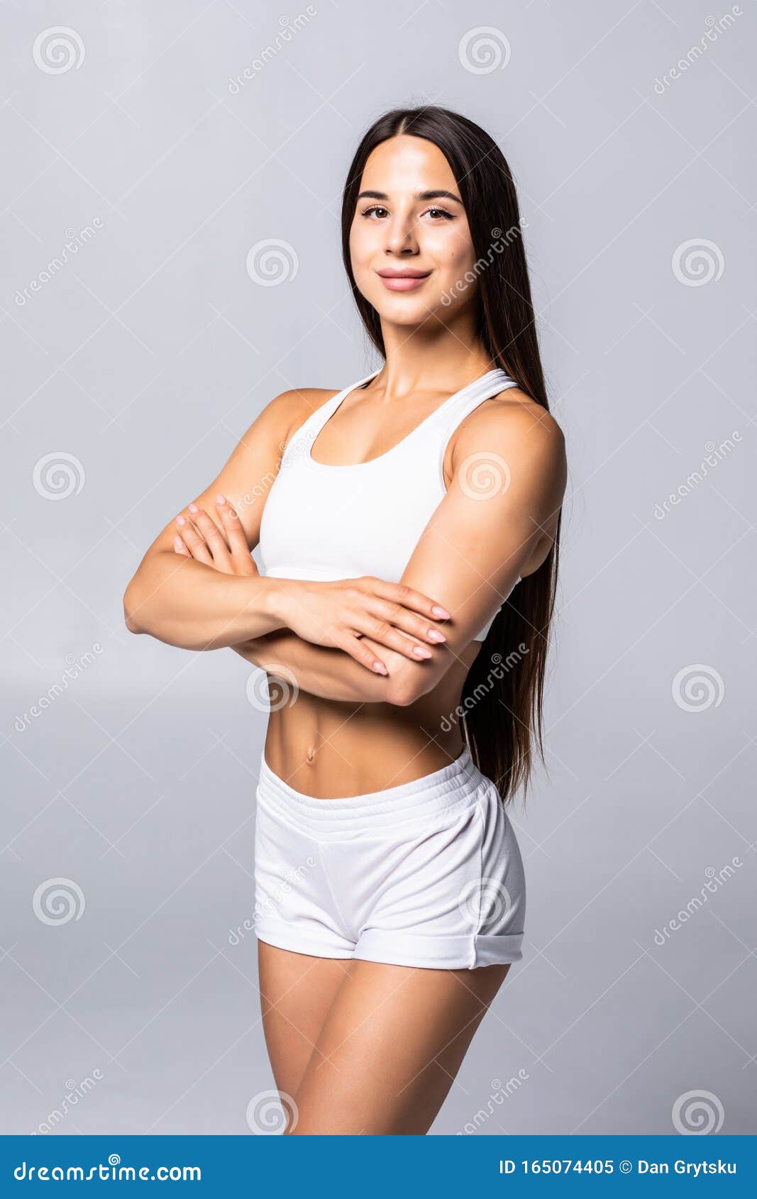 Smiling Sports Woman Standing with Arms Folded and Looking at Camera ... Smiling Sports Woman Standing with Arms Folded and Looking at Camera ...