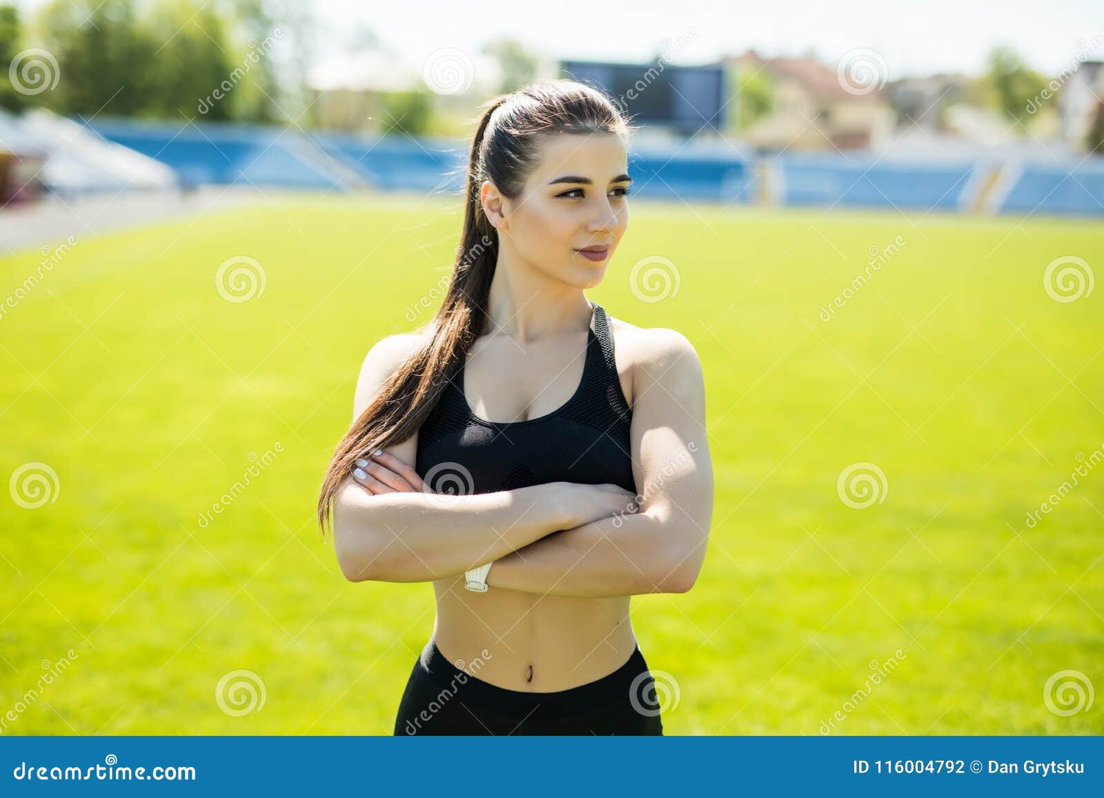 Slim Sport Woman. Smiling Sports Woman Standing with Arms Folded on the ... Slim Sport Woman. Smiling Sports Woman Standing with Arms Folded on the ...
