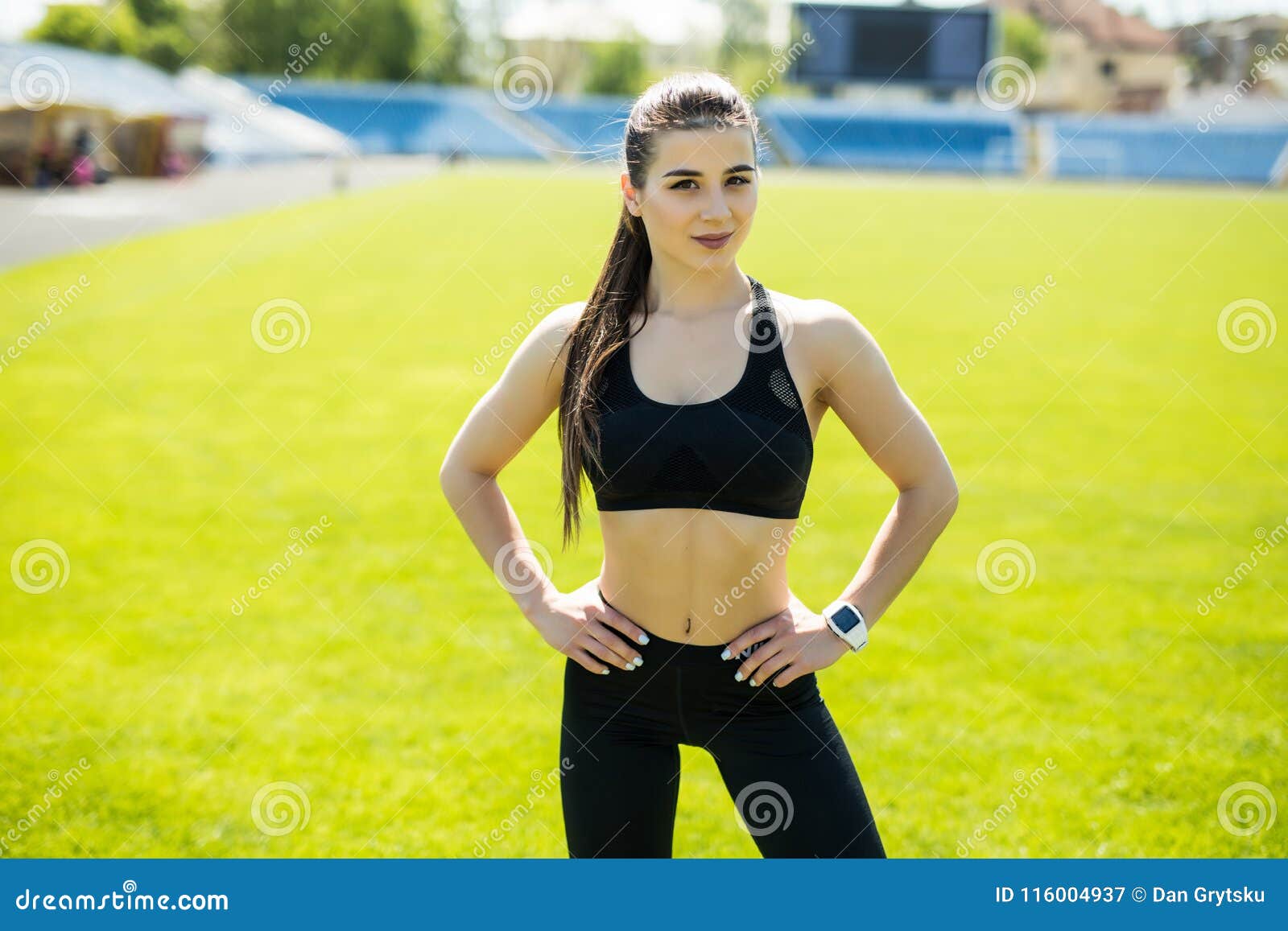 Sports Its Life. Smiling Sports Woman Standing with Arms Folded on the ... Sports Its Life. Smiling Sports Woman Standing with Arms Folded on the ...