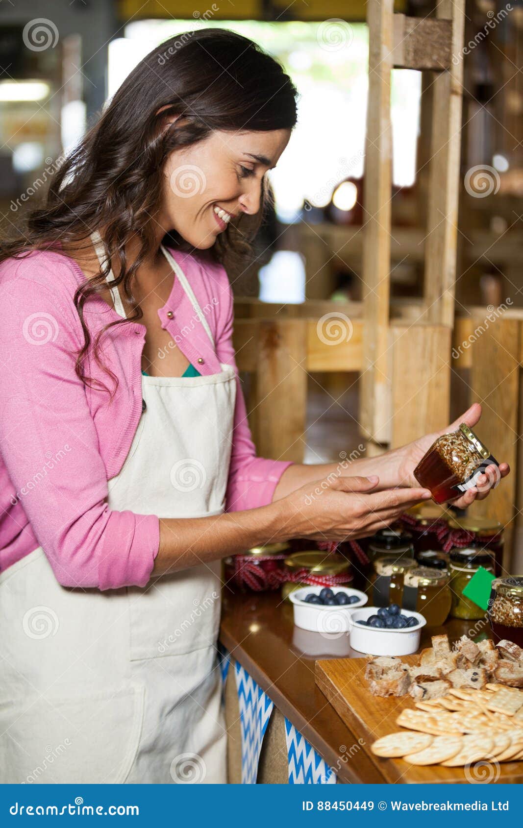 Smiling Staff Checking Jam Jar at Counter Stock Image - Image of ...