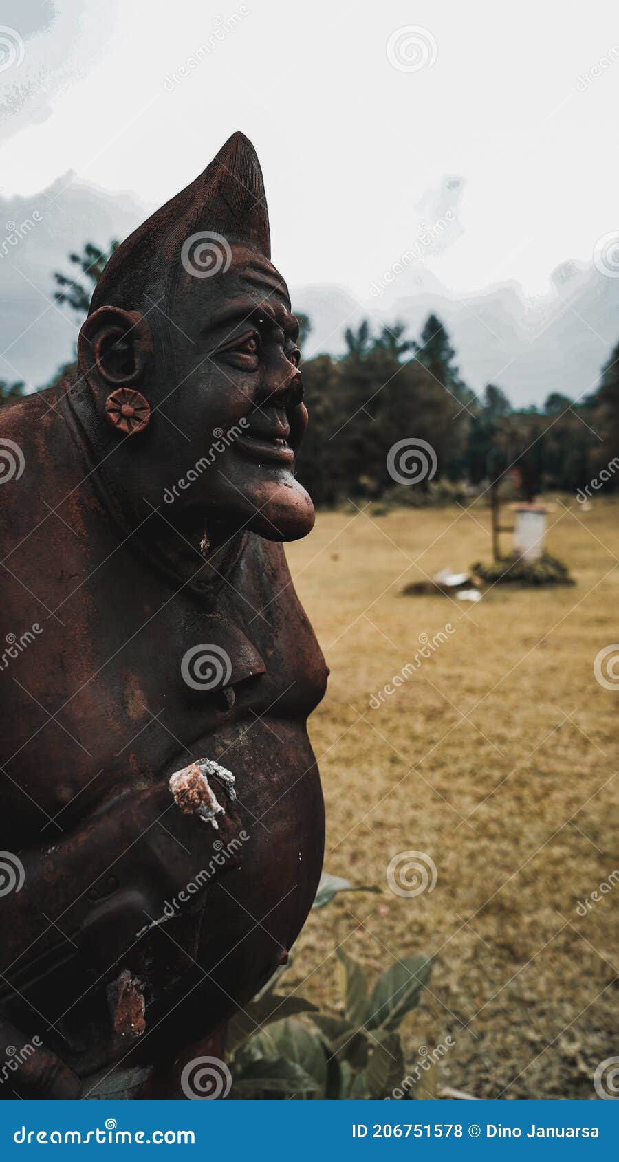 A Smiling Statue in the Fields Stock Photo - Image of stone, male ...