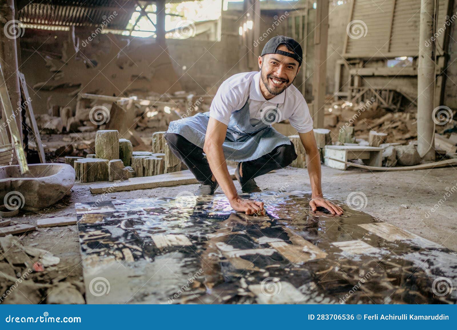 Smiling Stonemason Squats while Washing Large Squares of Stone Stock ...