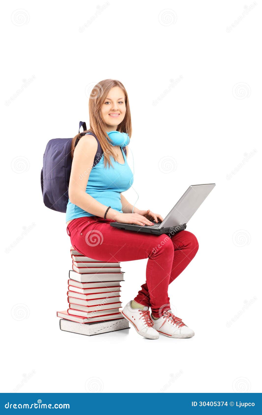 A Smiling Student with Backpack Working on a Laptop and Sitting Stock ...