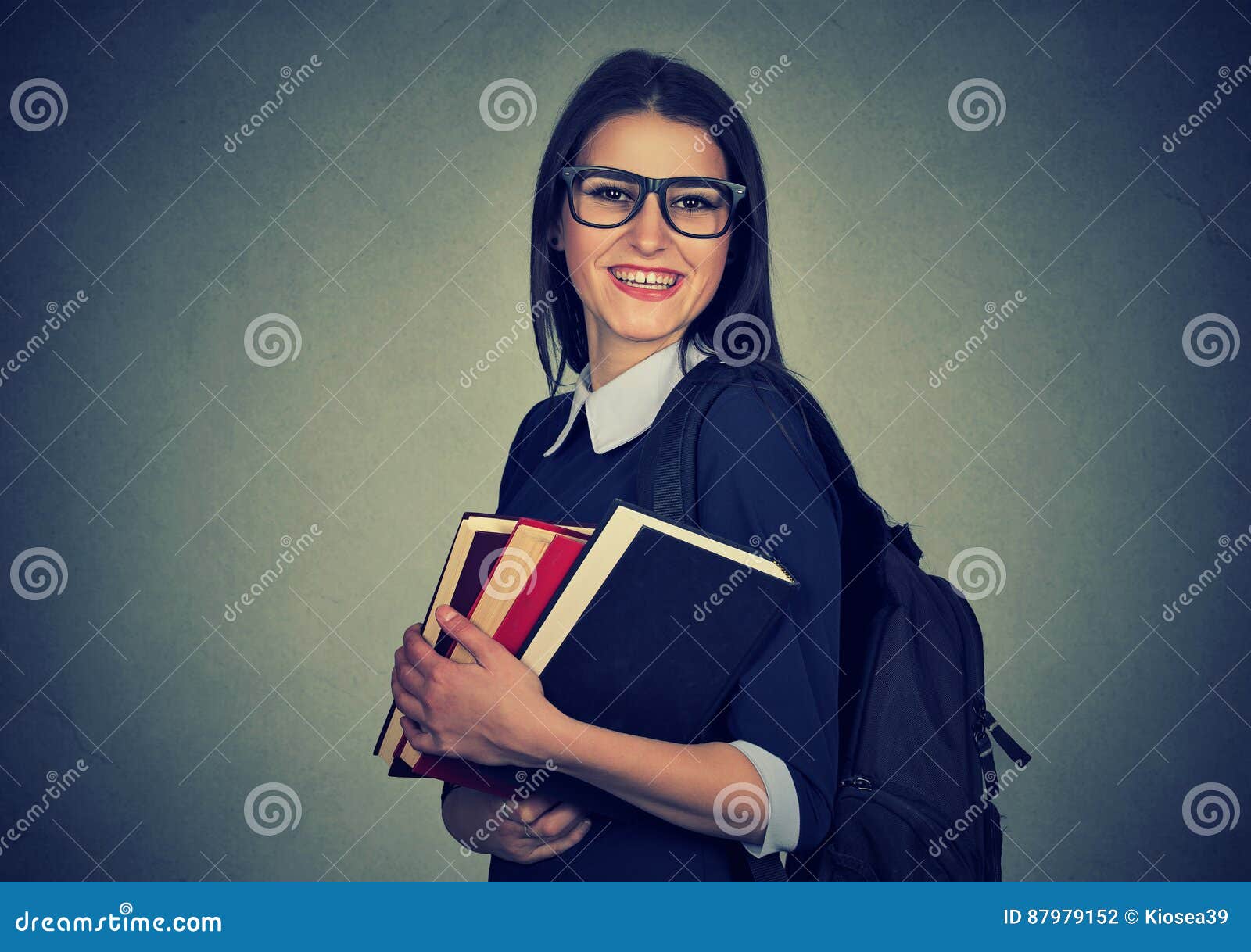 Smiling Student Carrying a Backpack and Holding Stack of Books Stock ...