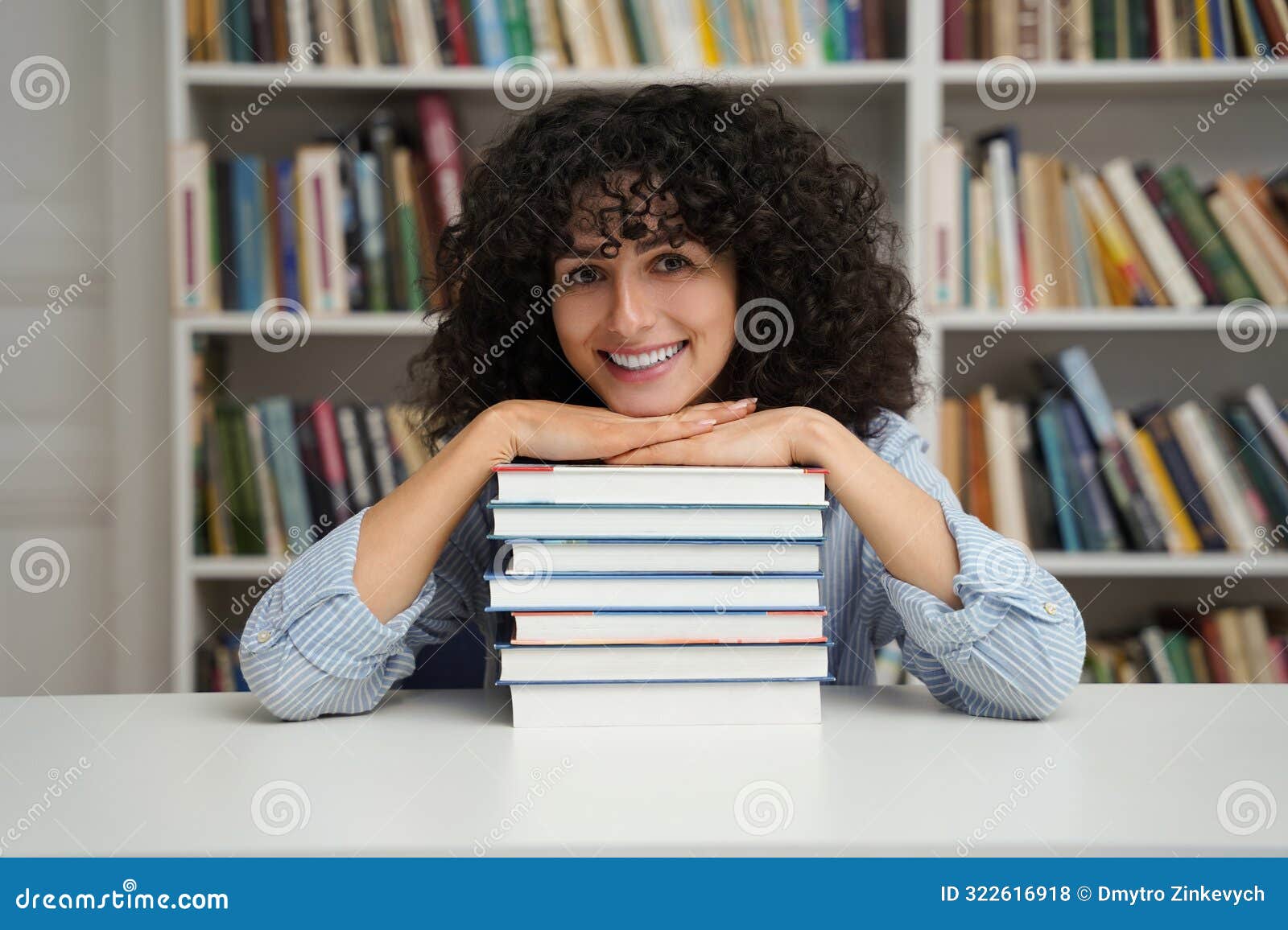 Smiling Student Girl Sitting at Desk with Stack of Books in Library ...