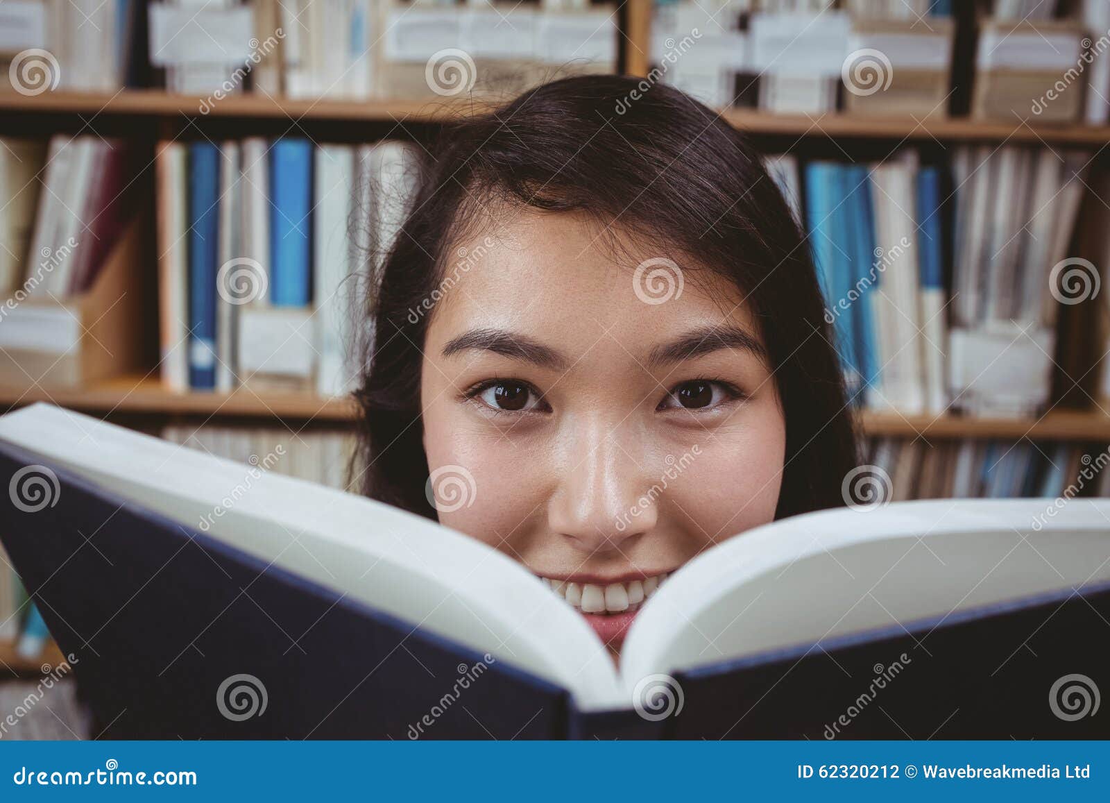 Smiling Student Hiding Face Behind a Book Stock Photo - Image of ...