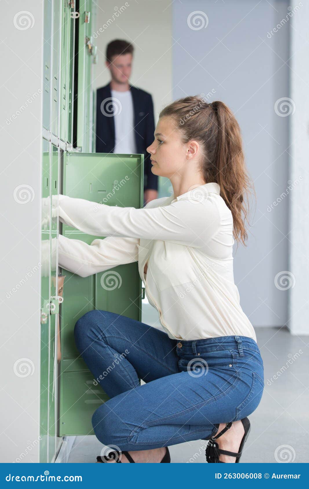 Smiling Student Opening Locker at University Stock Photo - Image of ...