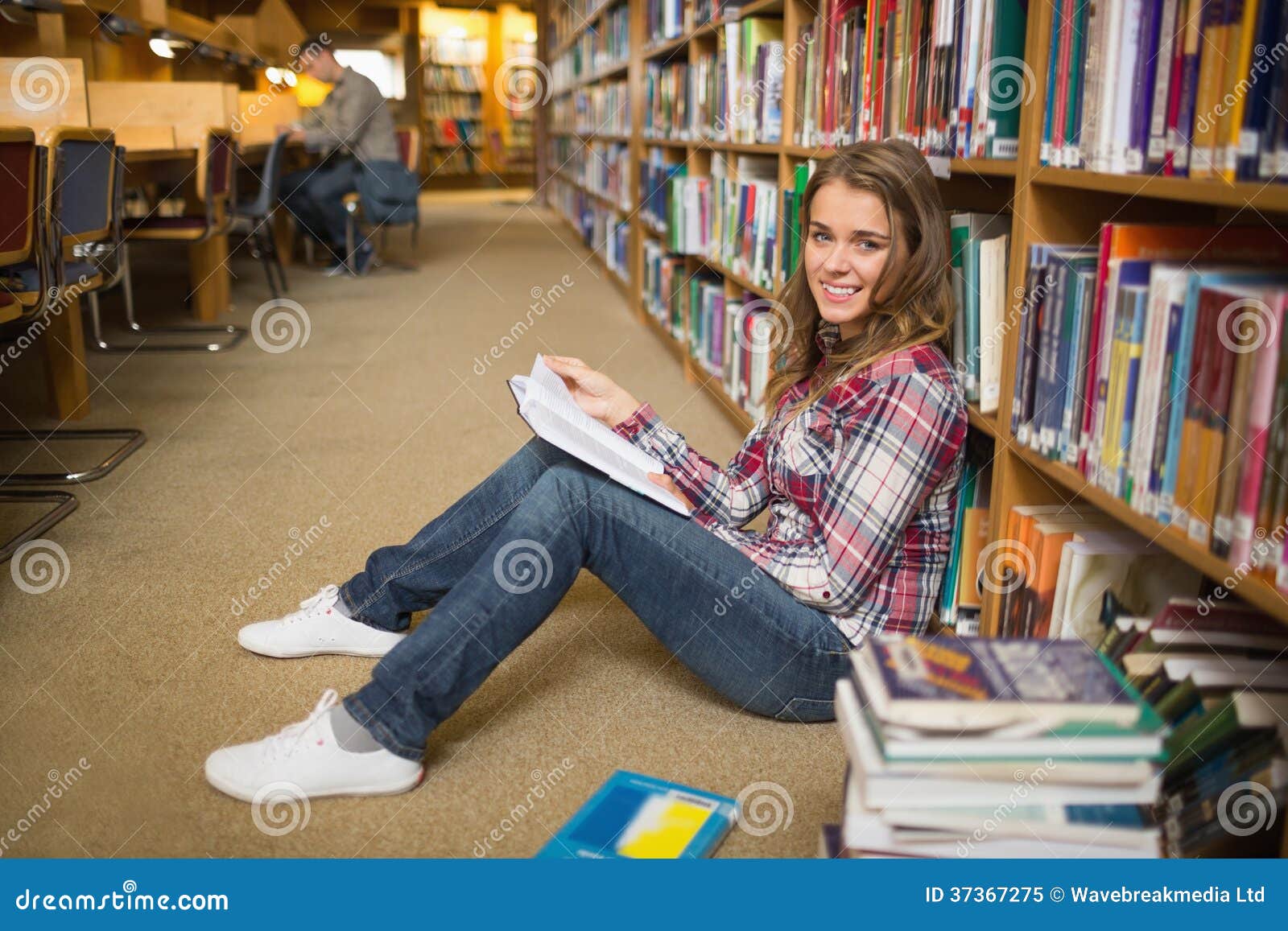 Smiling Student Reading Book on Library Floor Stock Image - Image of ...