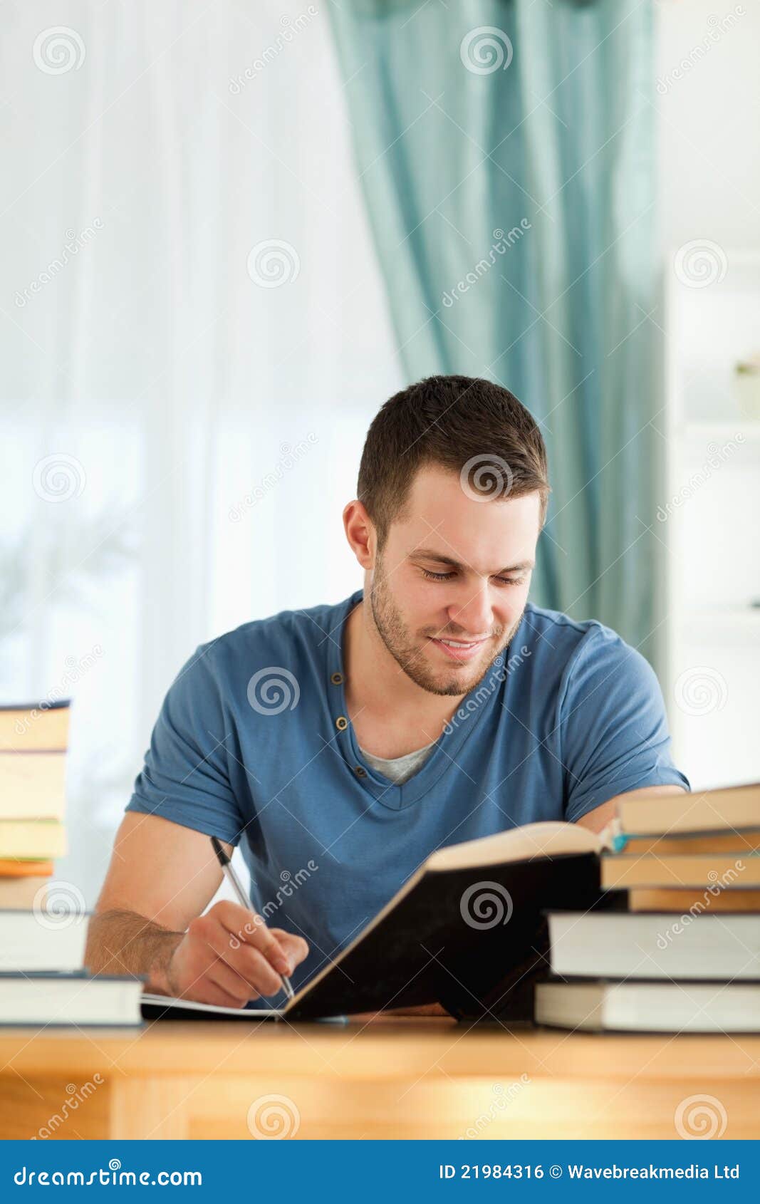 Smiling Student Reviewing His Subject Material Stock Photo - Image of ...