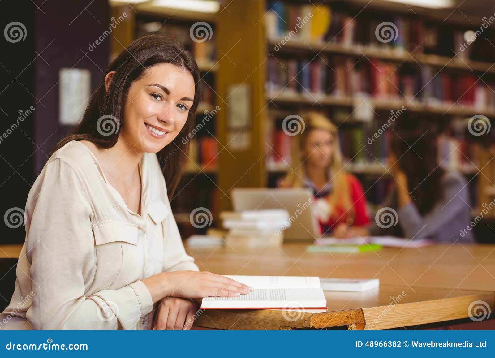 Smiling Student Sitting at Desk Reading Text Book Stock Photo - Image ...