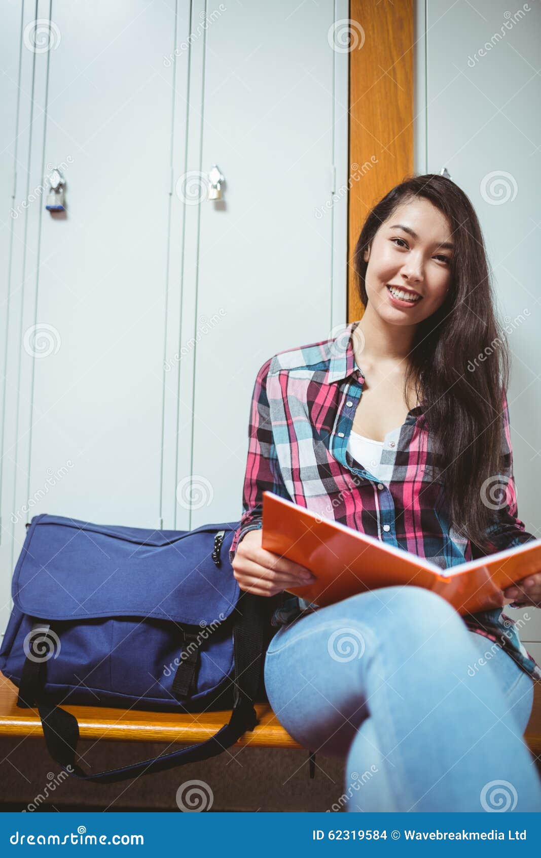 Smiling Student Sitting and Reading a Notebook Stock Photo - Image of ...