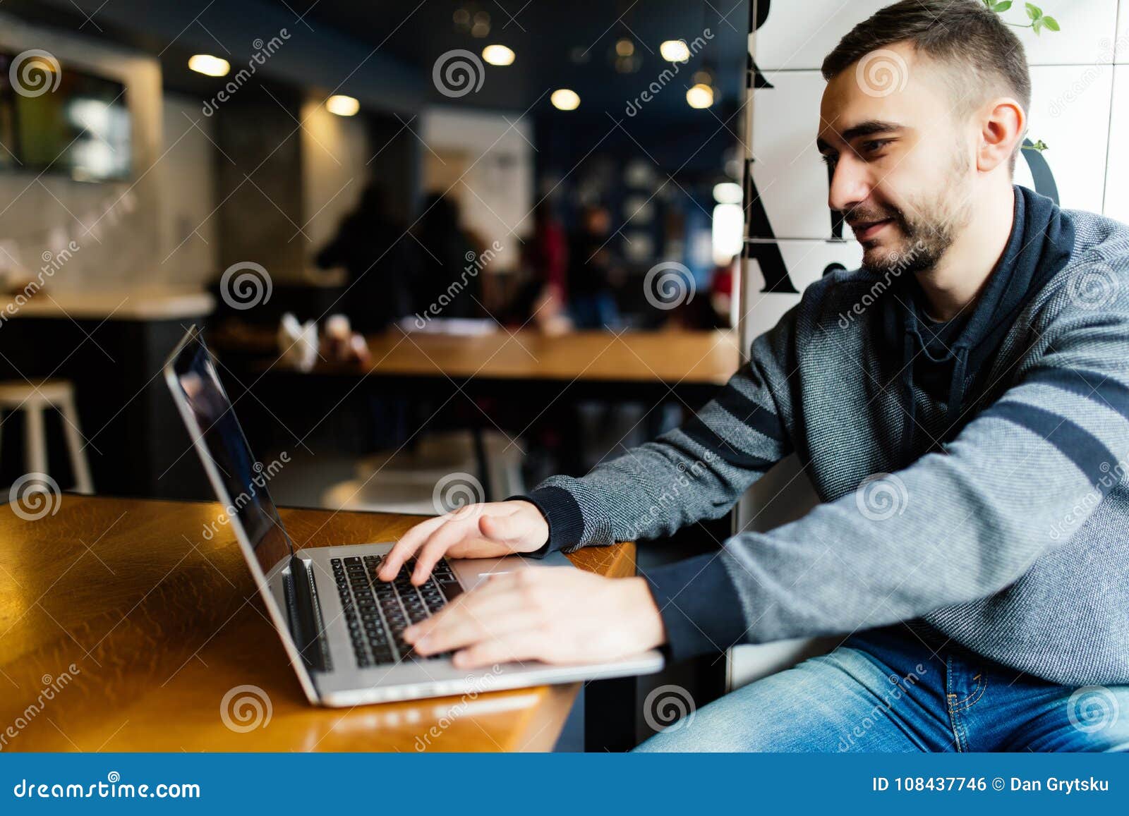 Smiling Student Using Laptop in Cafe at the University. Freelancer ...