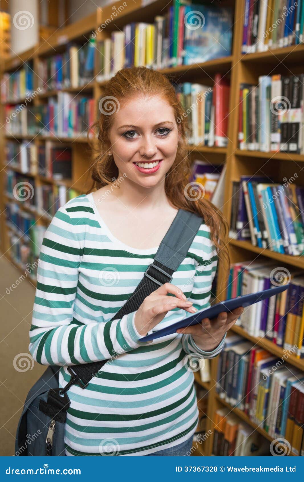 Smiling Student Using Tablet Standing in Library Stock Photo - Image of ...