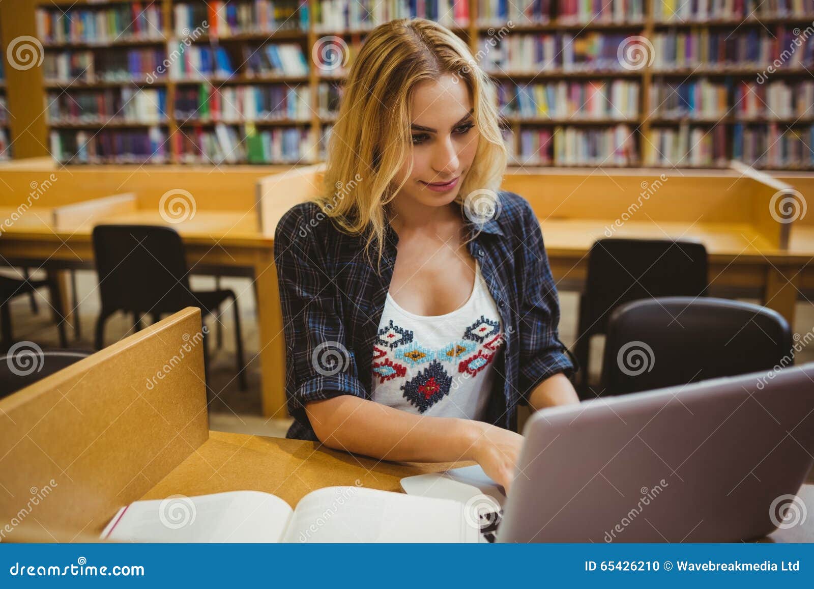 Smiling Student Working while Using Her Laptop Stock Photo - Image of ...