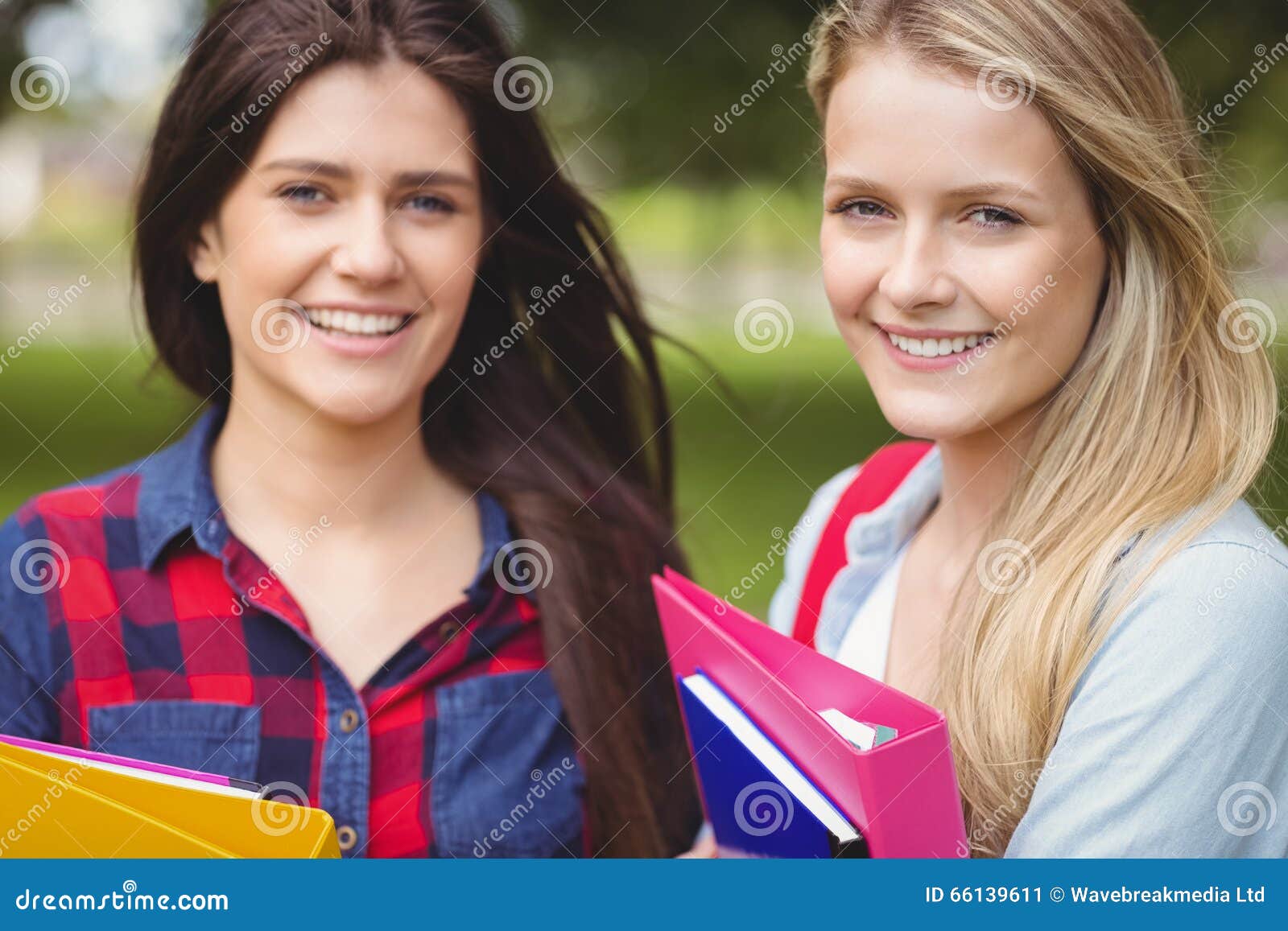 Smiling Students Holding Binder Stock Image - Image of friends, female ...