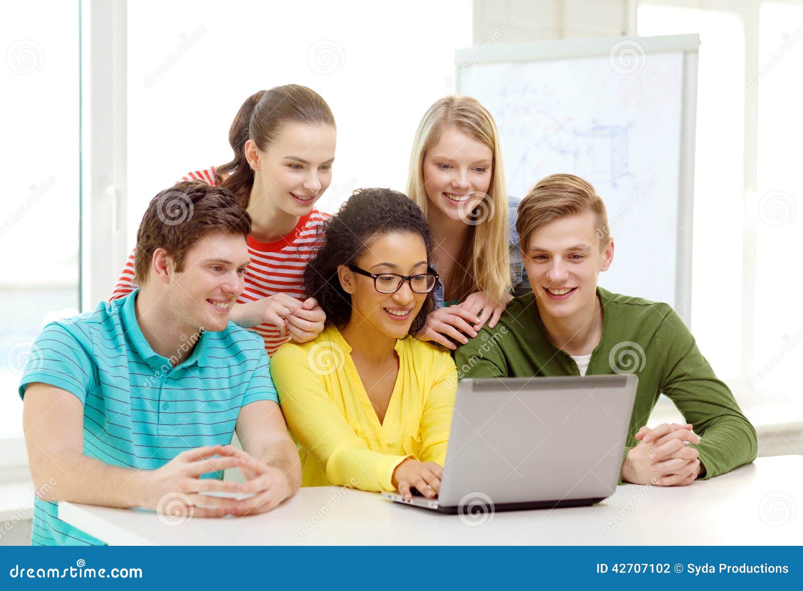 Smiling Students Looking at Laptop at School Stock Photo - Image of ...