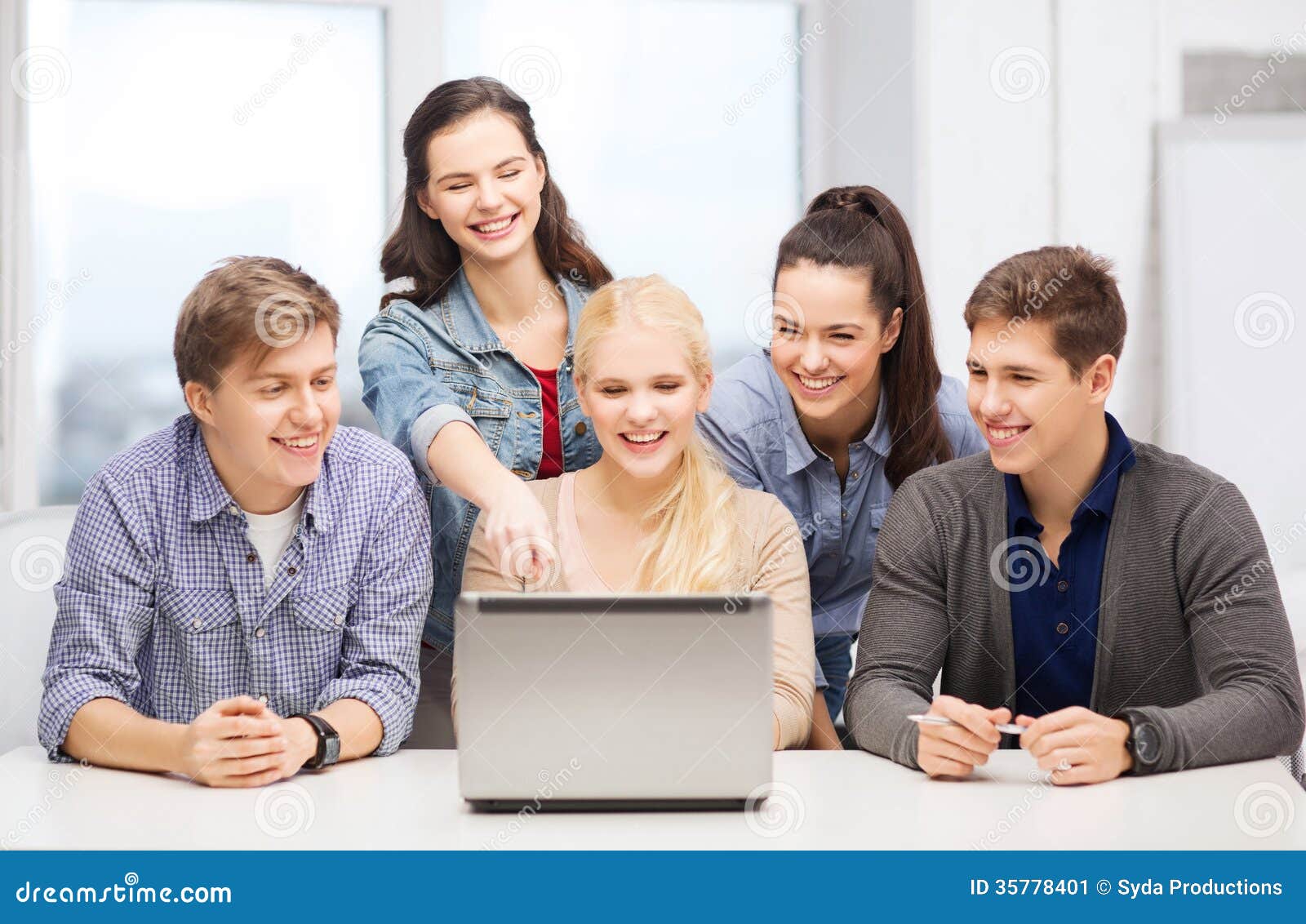 Smiling Students Looking at Laptop at School Stock Image - Image of ...