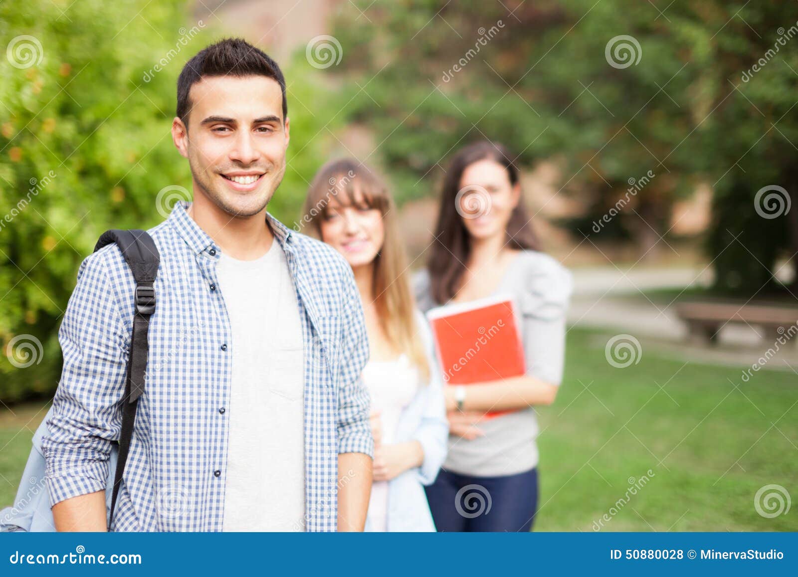 Smiling students in a park stock photo. Image of person - 50880028