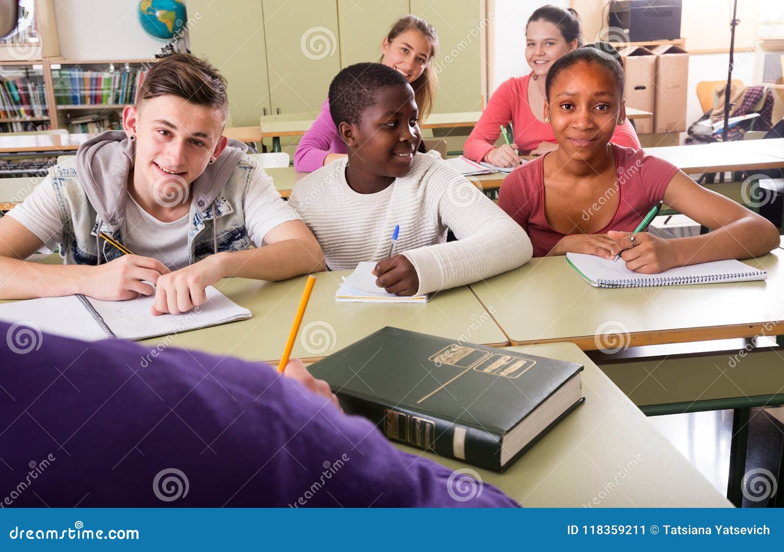 Smiling Students Sitting at Their Desks in Classroom Stock Image ... Smiling Students Sitting at Their Desks in Classroom Stock Image ...