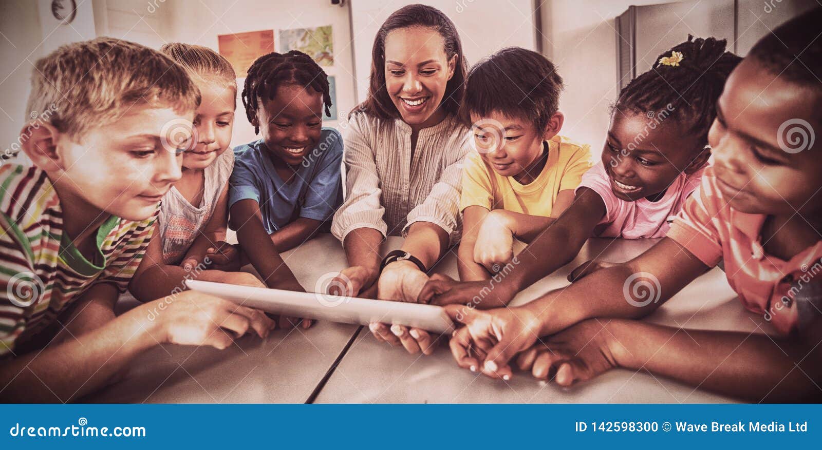 Smiling Students and Teacher Using a Tablet Computer Stock Photo ...