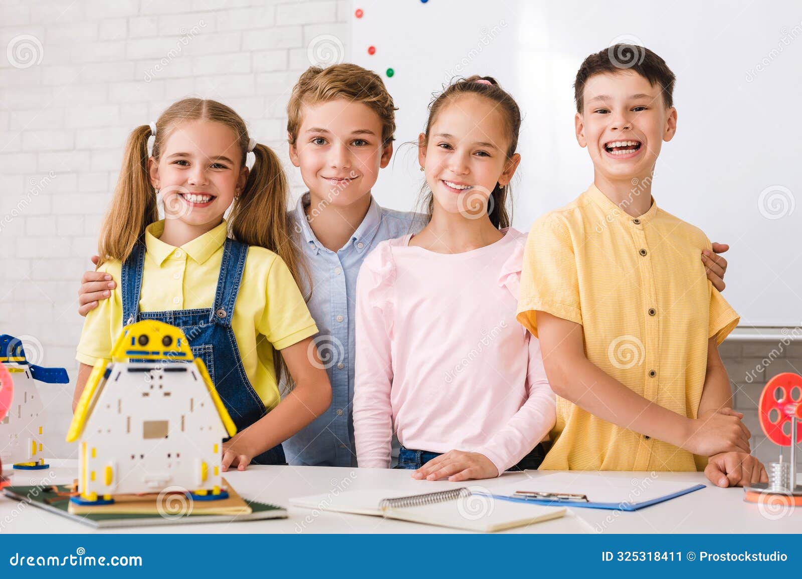 Smiling Students Working on Robotics Project in Classroom Stock Image ...
