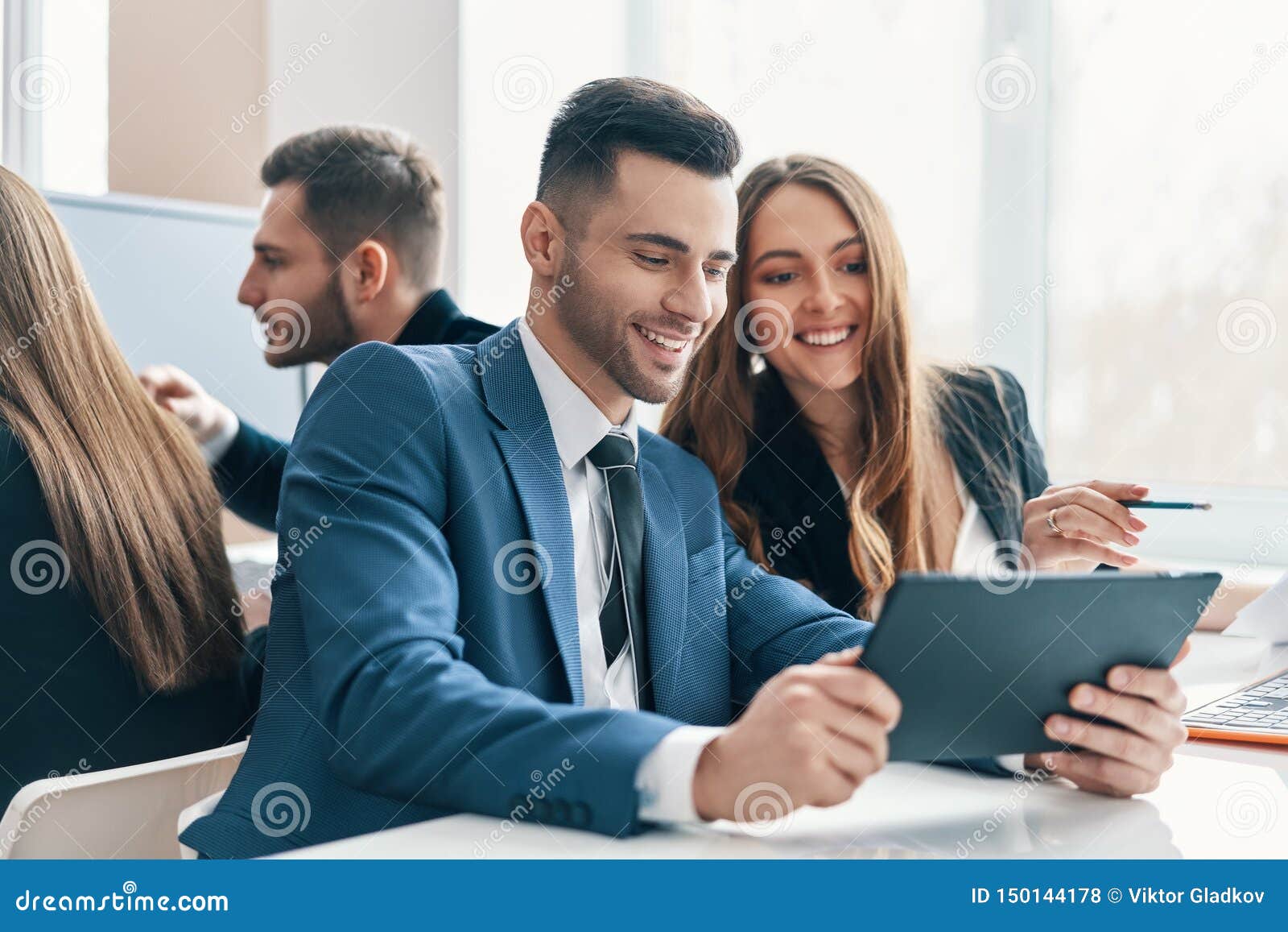 Smiling Successful Business People Discussing Ideas Using Digital ...