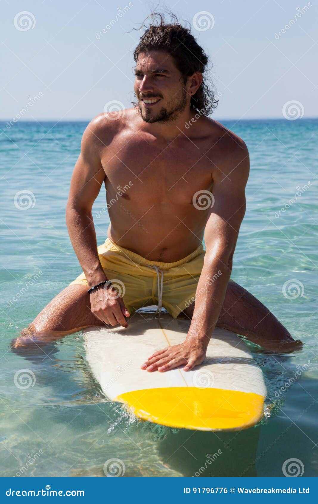 Smiling Surfer Sitting on Surfboard at Seacoast Stock Photo - Image of ...