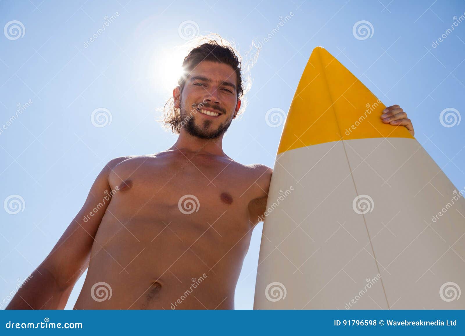 Smiling Surfer with Surfboard Standing Against Blue Sky Stock Photo ...