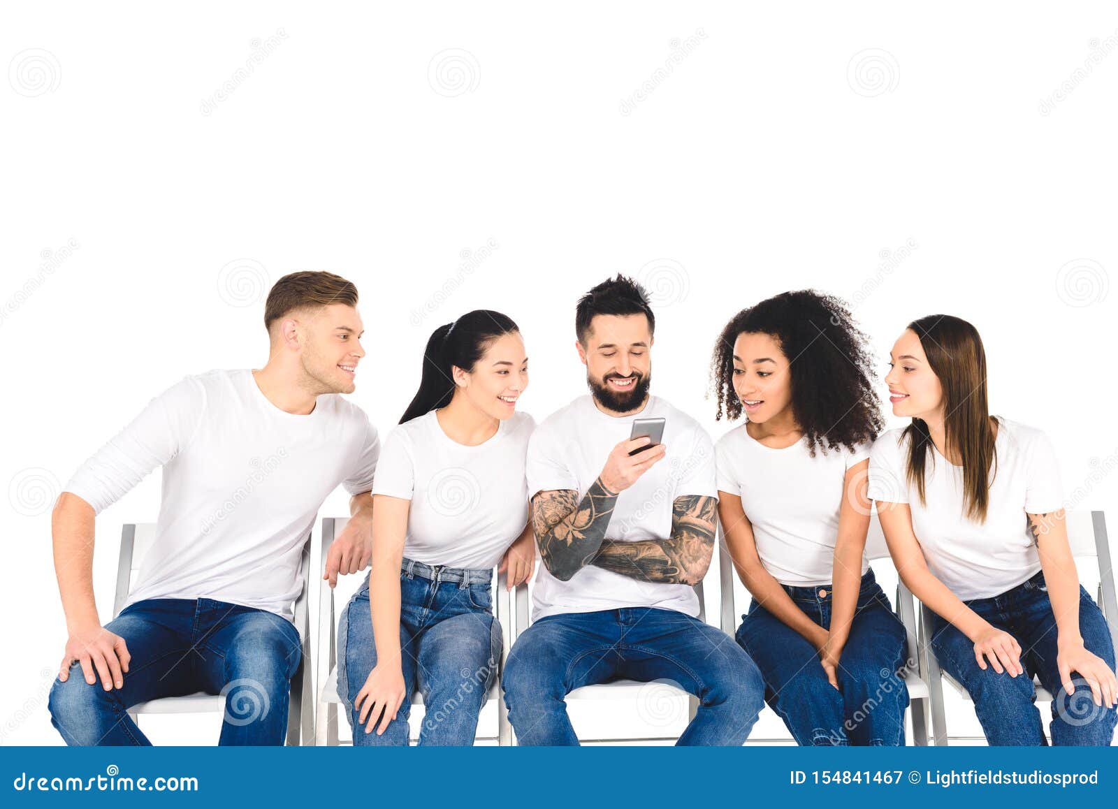 Smiling Tattooed Man Using Smartphone while Multiethnic Curious Young ...