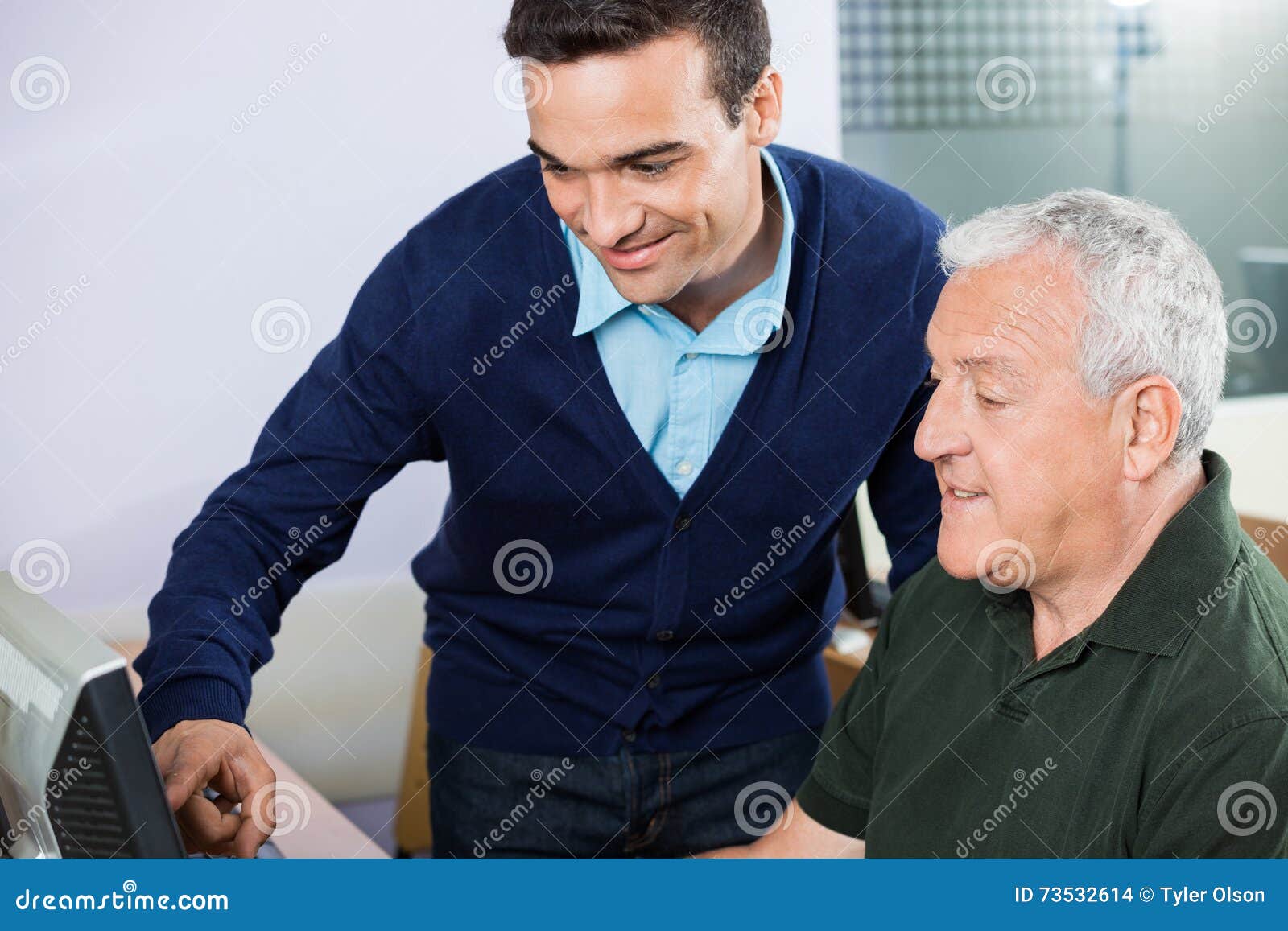 Smiling Teacher Assisting Senior Man in Using Computer Stock Photo ...