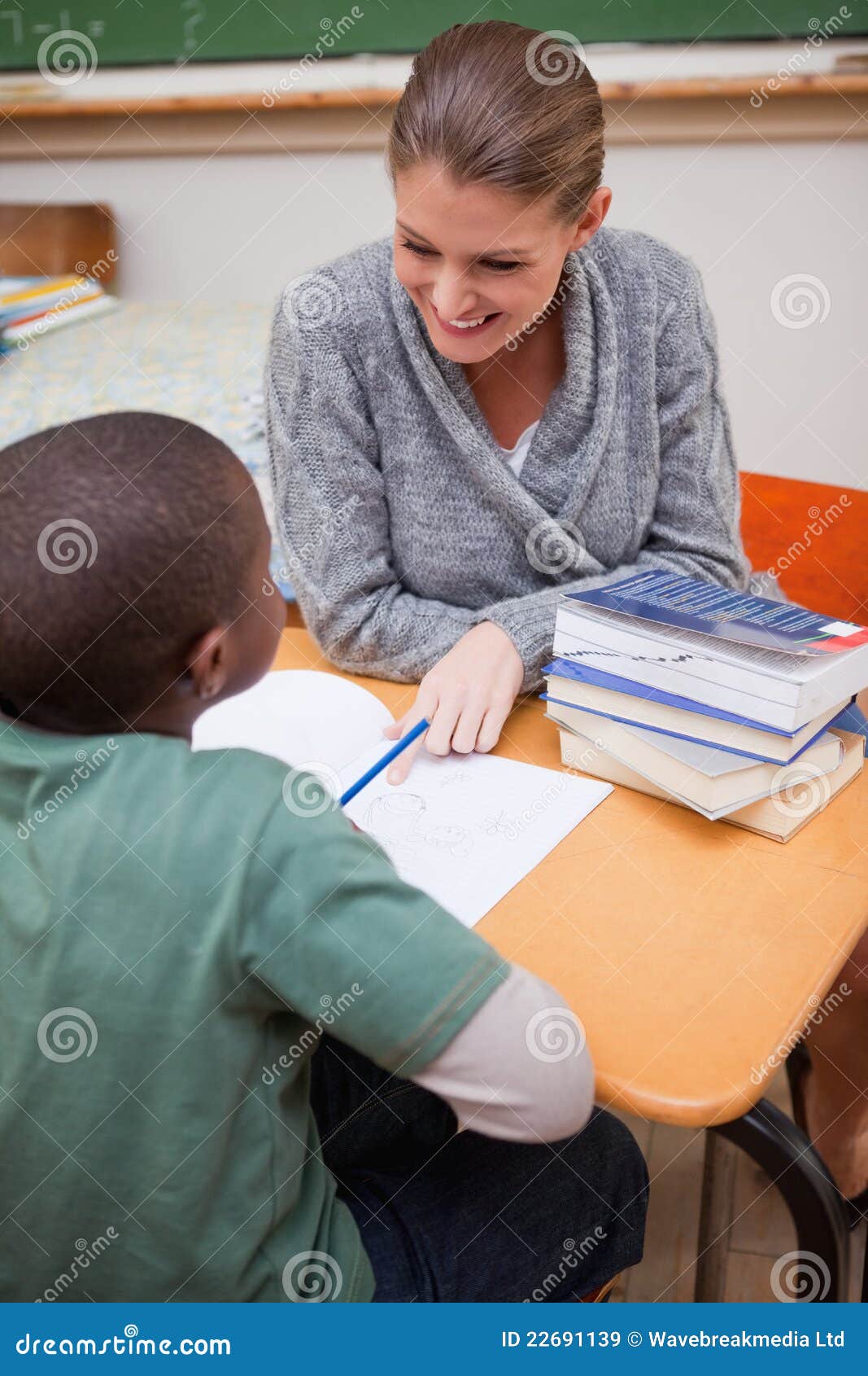 A Smiling Teacher Explaining Something To a Pupil Stock Image - Image ...