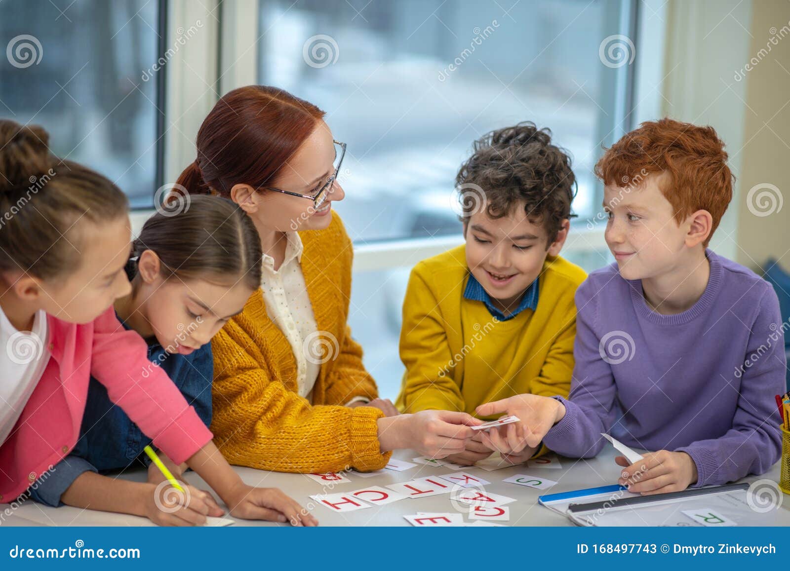 Smiling Teacher Explaining the Task To Her Students a School Stock ...