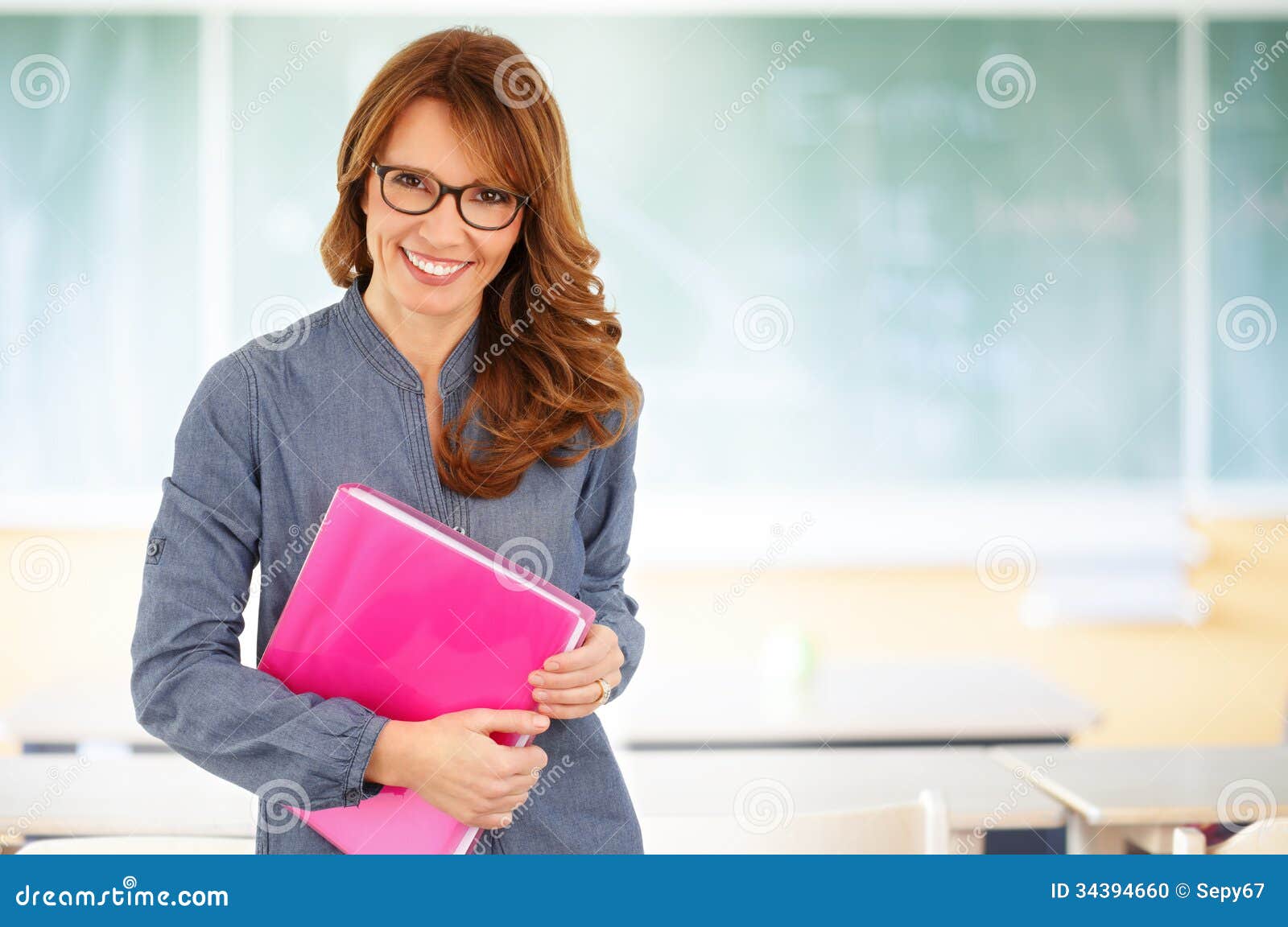 Smiling Teacher in Front of the Blackboard Stock Photo - Image of arms ...