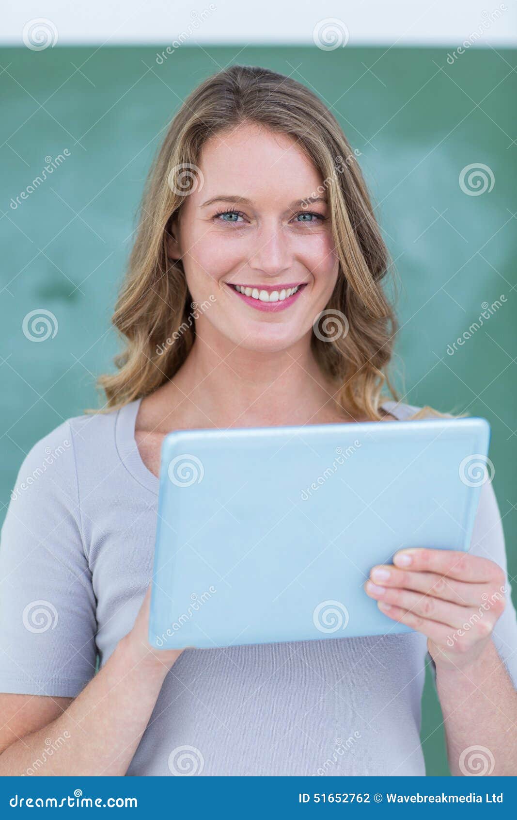 Smiling Teacher Holding Tablet Pc Stock Photo - Image of career, female ...