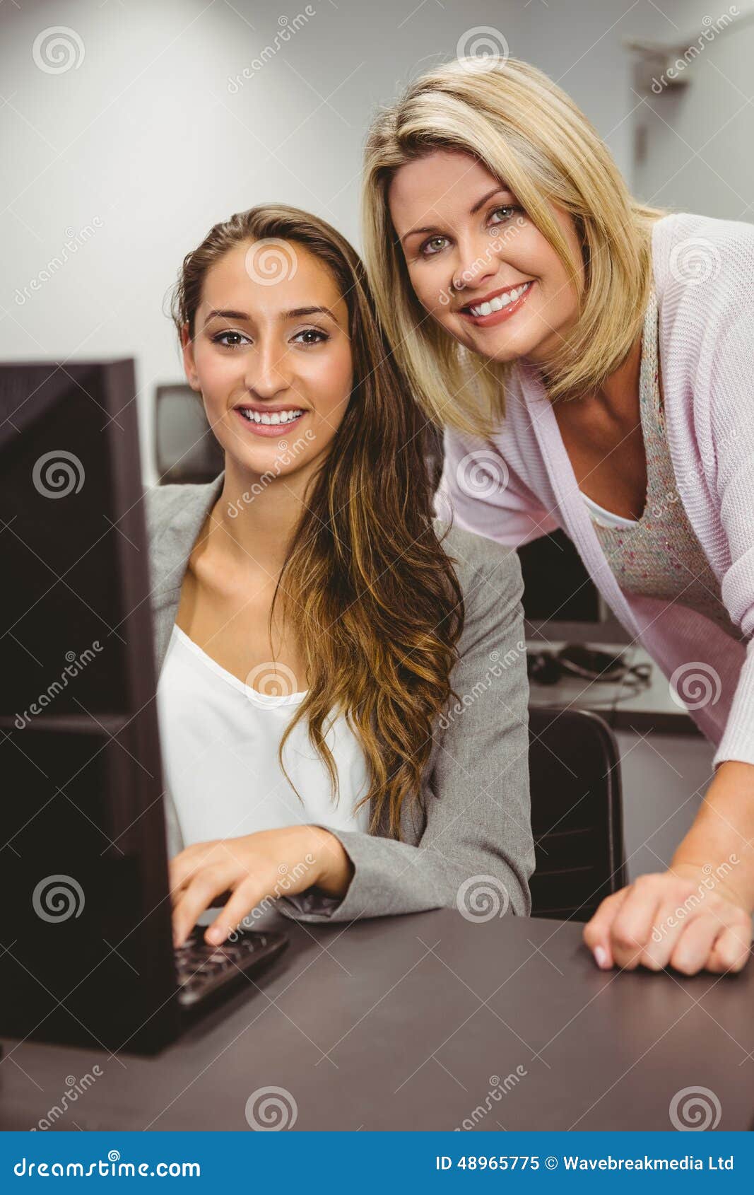 Smiling Teacher and Student Behind Desk at Computer Stock Image - Image ...